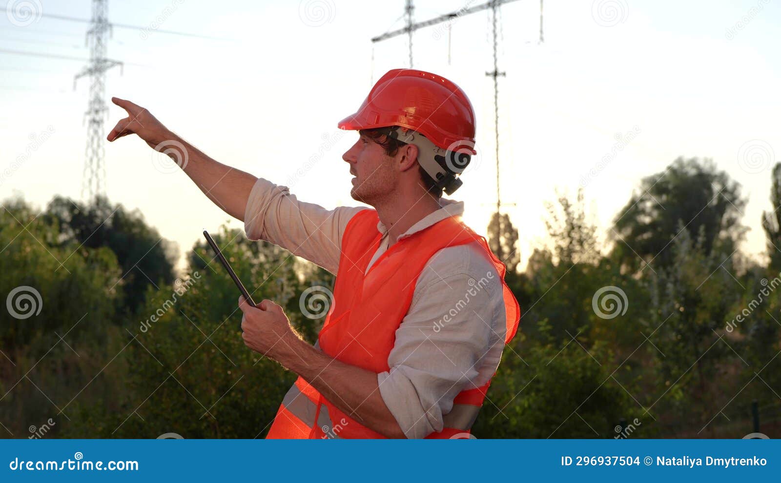 Smiling Young Electrical Engineer Standing Outdoors while Holding ...