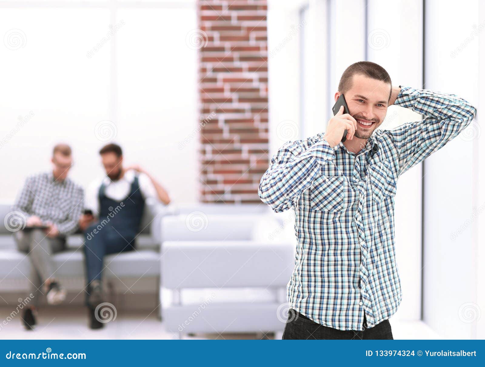 Smiling Young Employee Standing in the Office Stock Photo - Image of ...