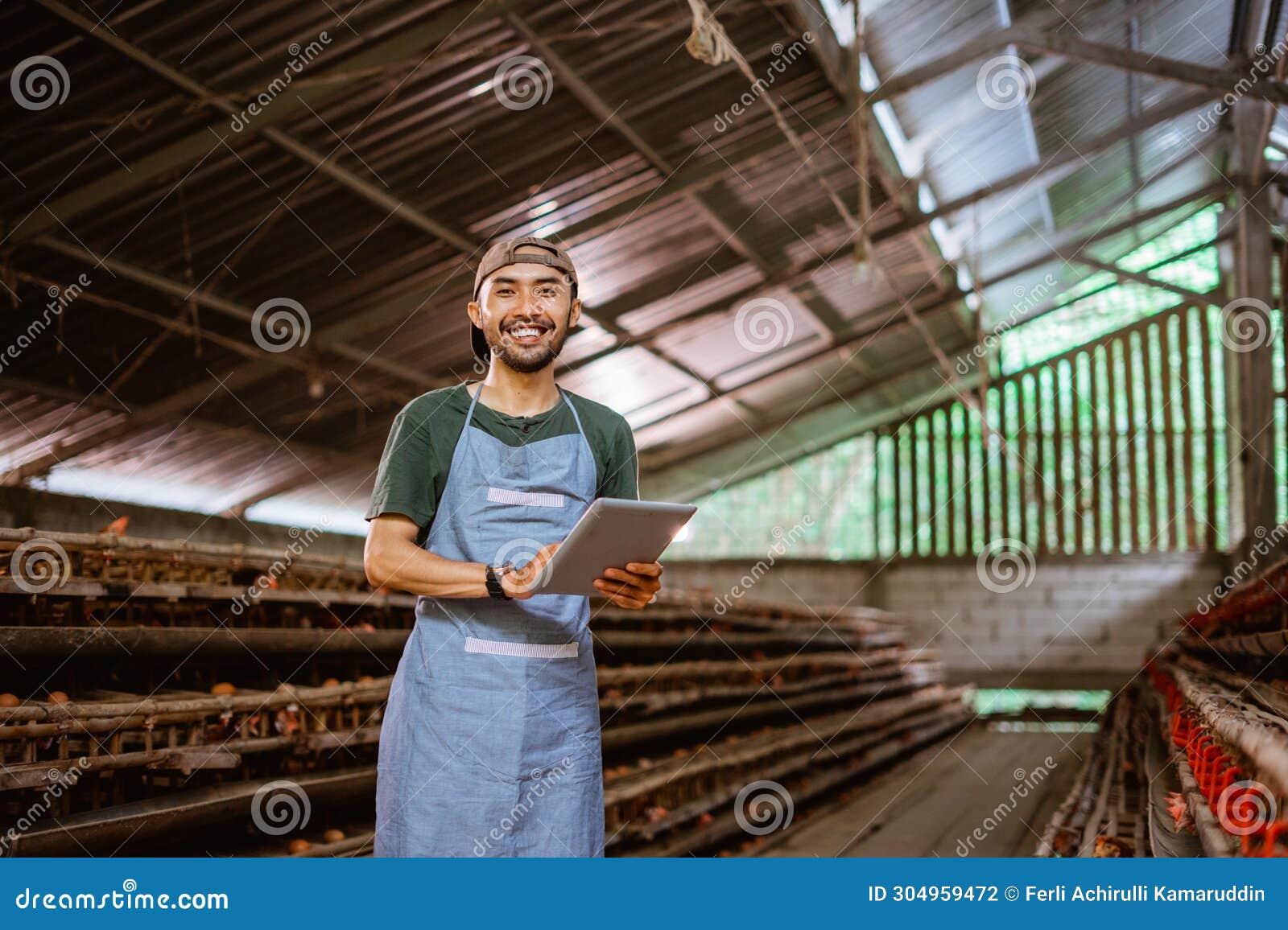 Smiling Young Entrepreneur Using a Pad Standing on Chicken Farm Stock ...