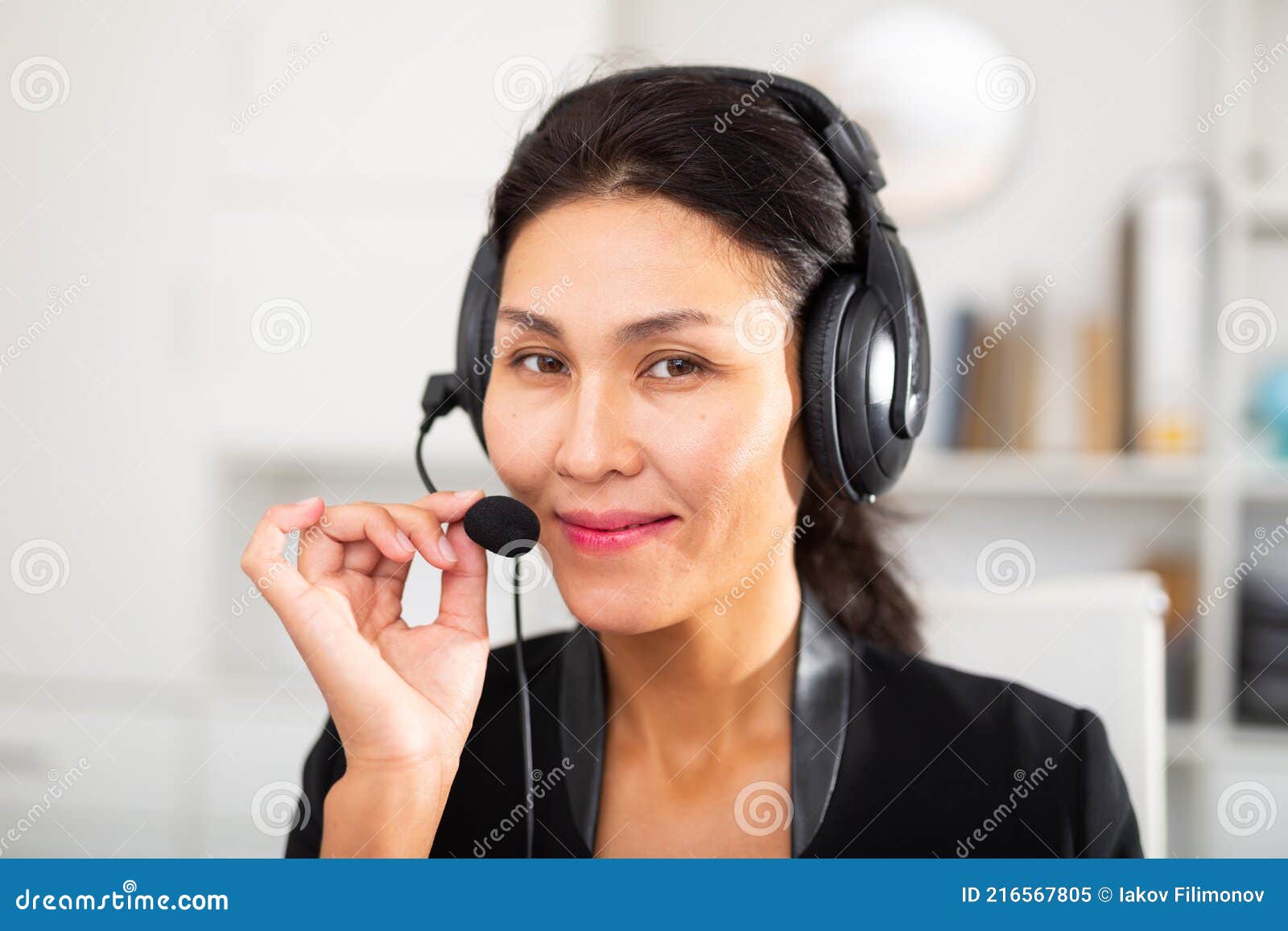 Smiling Young Female Operator Talking with Customer Using Headset at ...