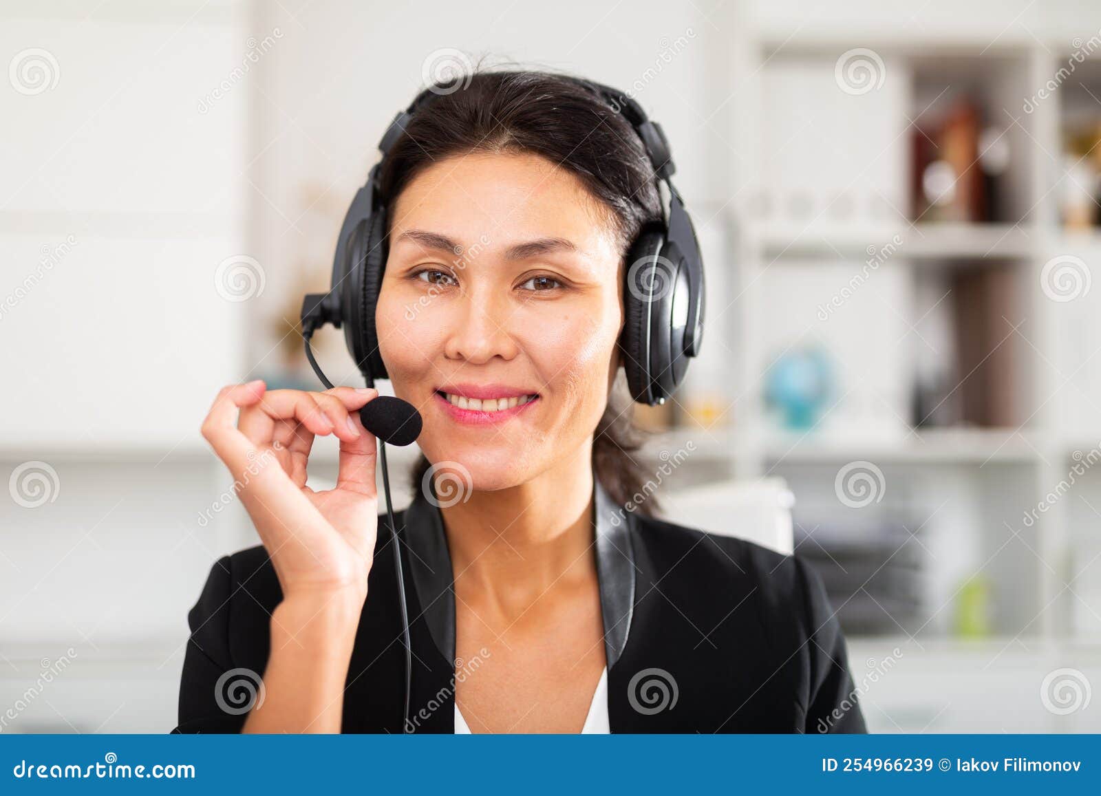 Smiling Young Female Operator Talking with Customer Using Headset at ...