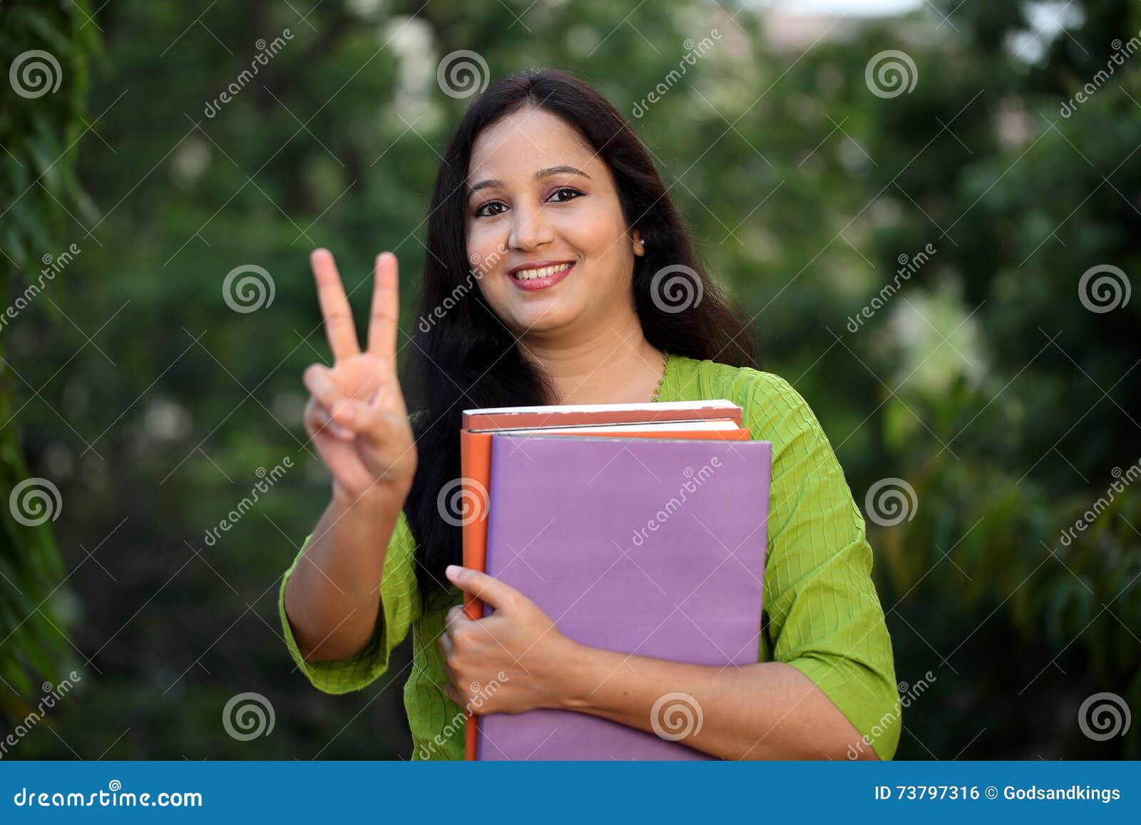 Smiling Young Female Student Making Victory Sign Stock Photo - Image of ...