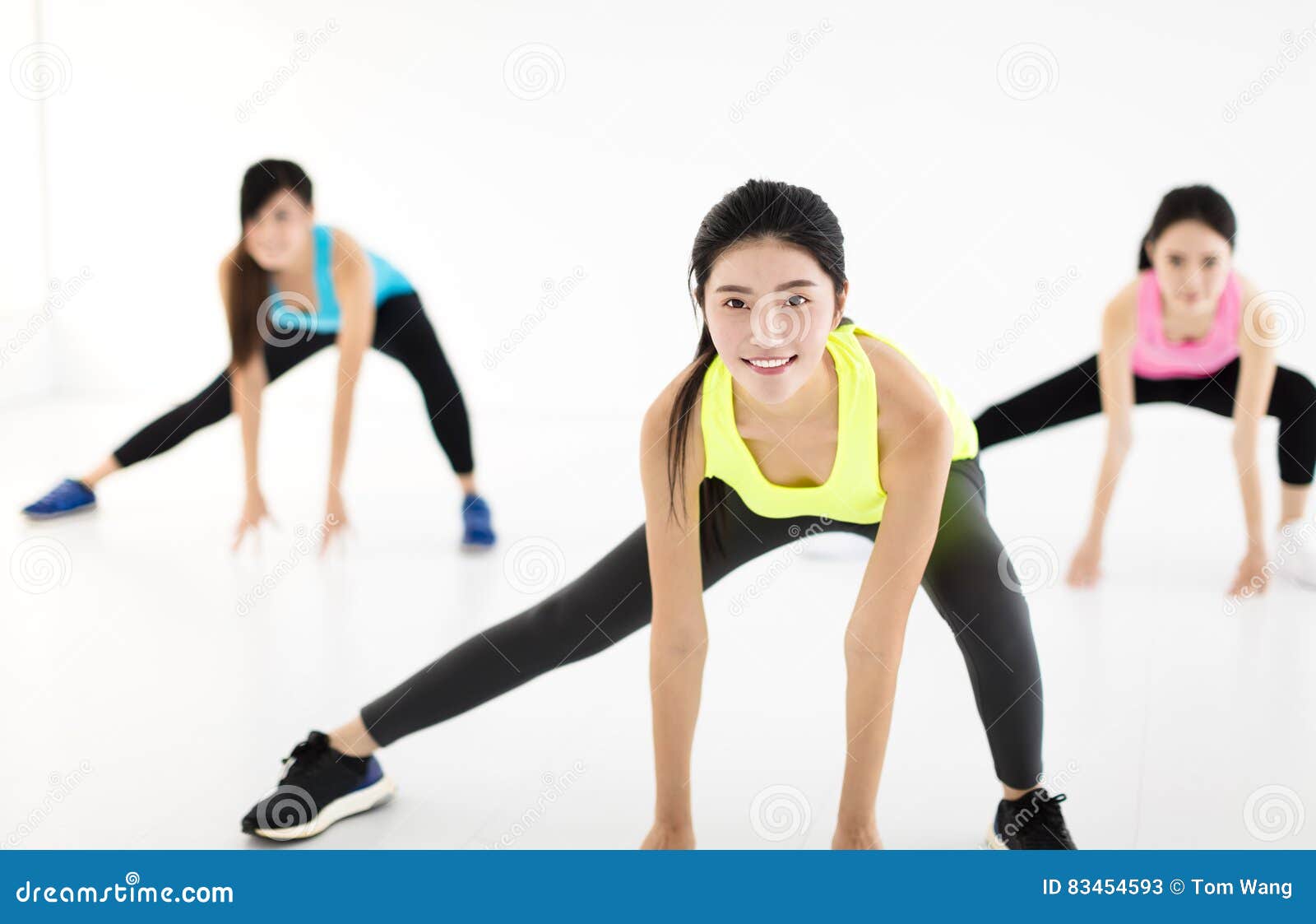Smiling Young Fit Group Stretching in Gym Stock Image - Image of ...