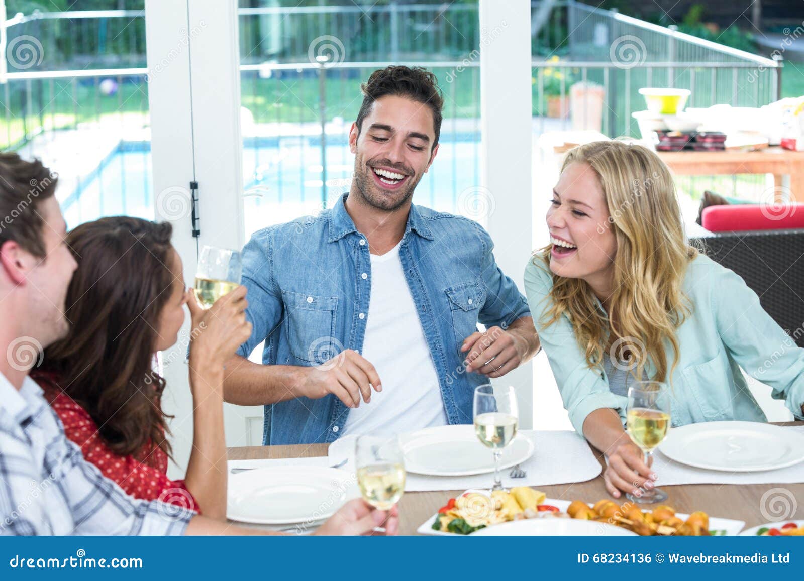 Smiling Young Friends Discussing Stock Photo - Image of casual, focus ...