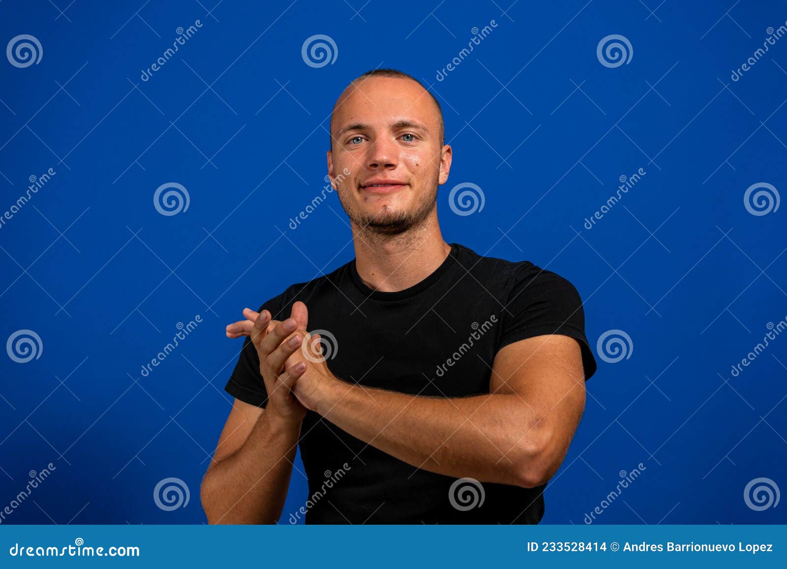 Smiling Young Handsome Man Clapping Hands on Blue Studio Background ...