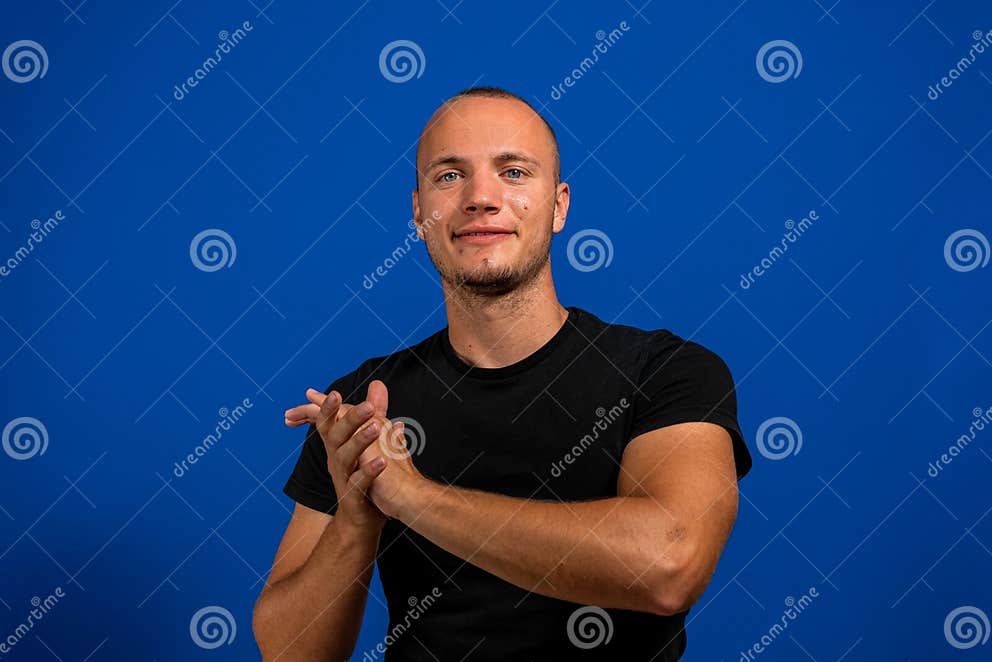 Smiling Young Handsome Man Clapping Hands on Blue Studio Background ...