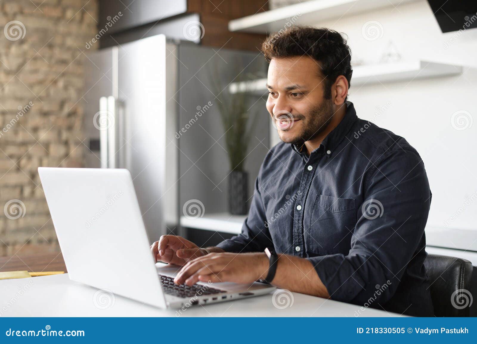 Smiling Young Indian Guy Using a Laptop for Remote Work from Home Stock ...