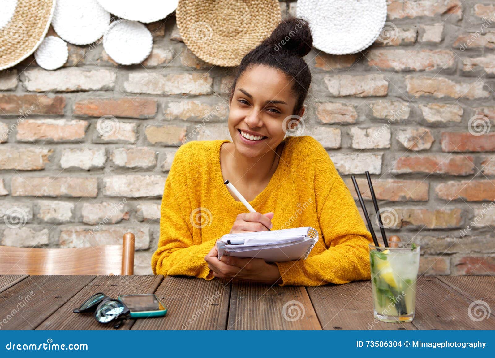 Smiling Young Lady Sitting at Cafe with Notepad Stock Photo - Image of ...