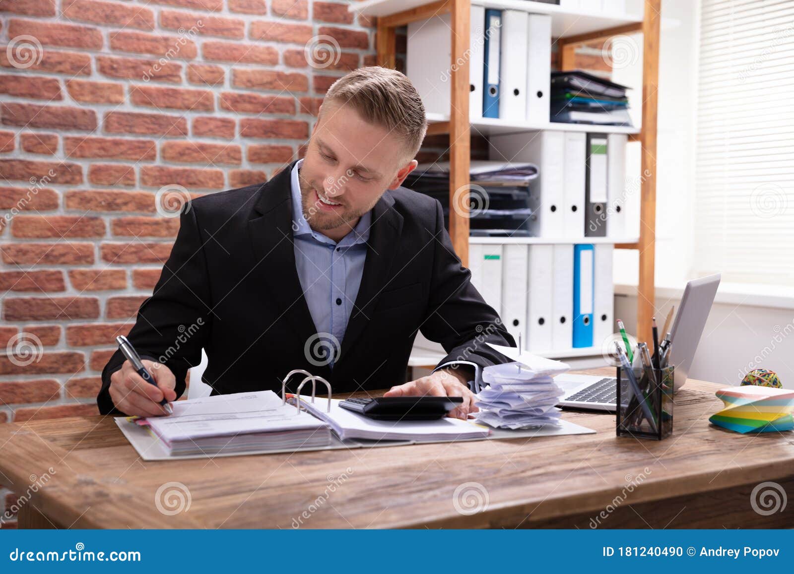Male Accountant Calculating Invoice with Calculator in Office Stock ... Male Accountant Calculating Invoice with Calculator in Office Stock ...