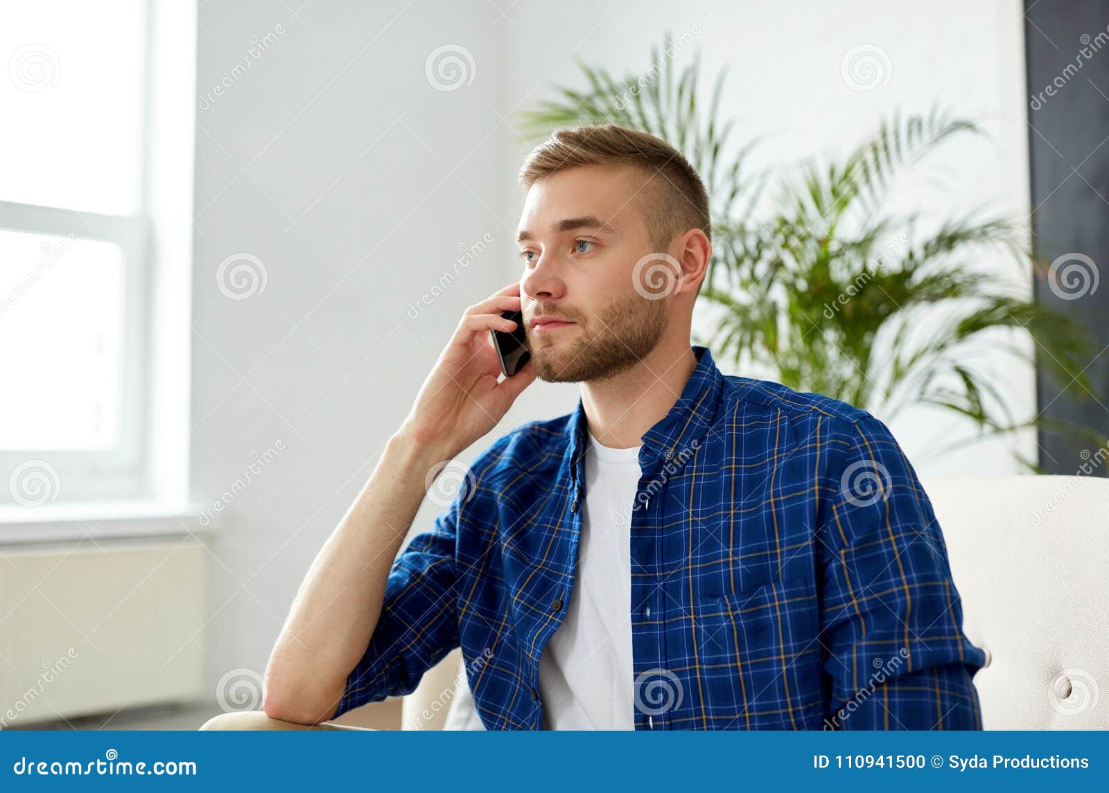 Smiling Young Man Calling on Smartphone at Office Stock Photo - Image ...