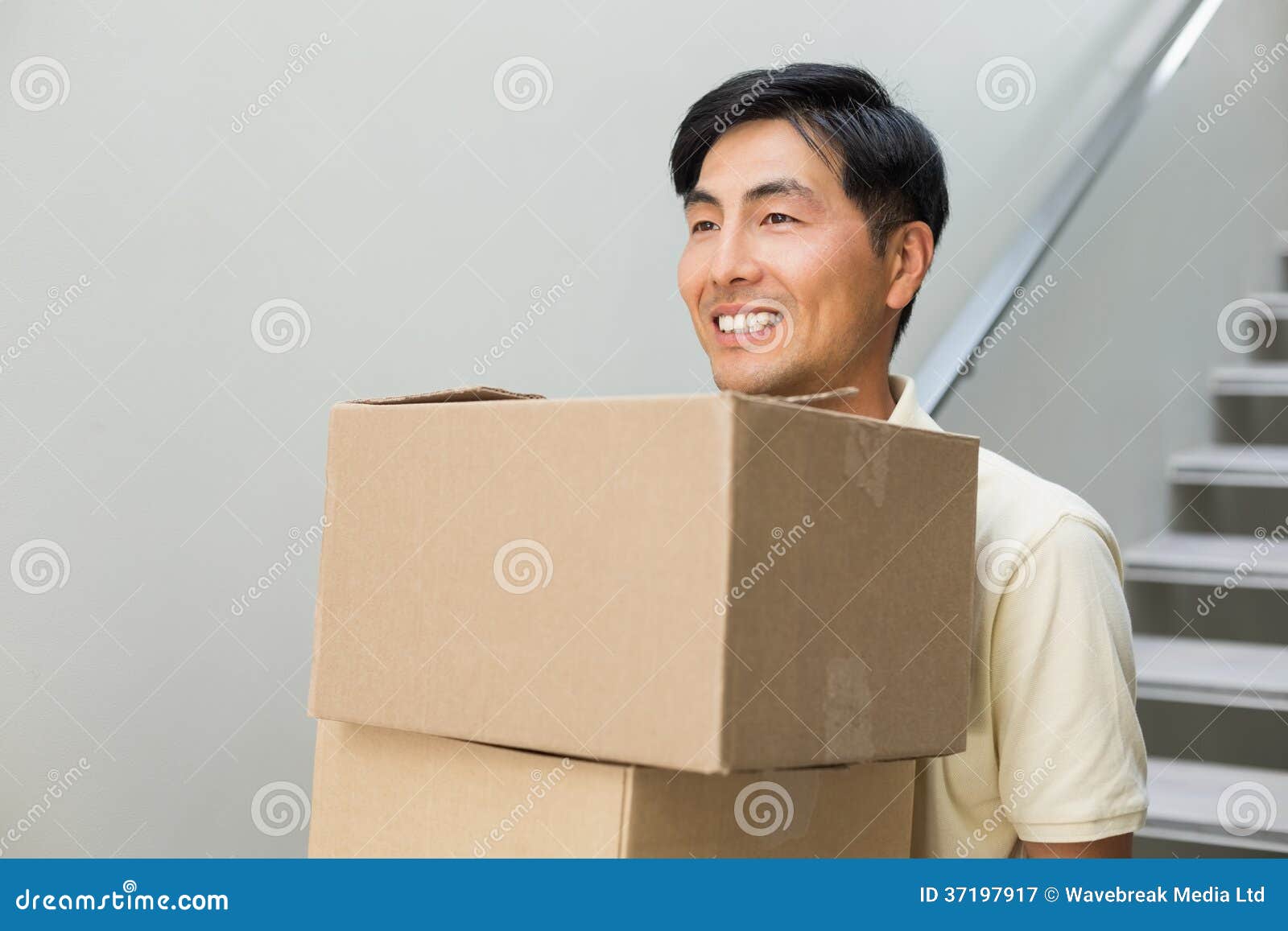 Smiling Young Man Carrying Boxes Stock Image - Image of moving, indoors ...