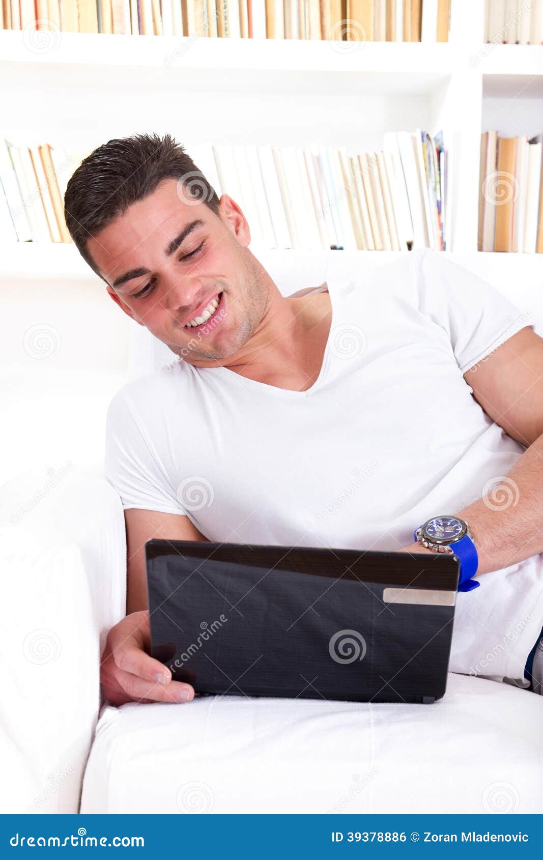 Smiling Young Man Chatting on Laptop Computer at Home Stock Photo ...