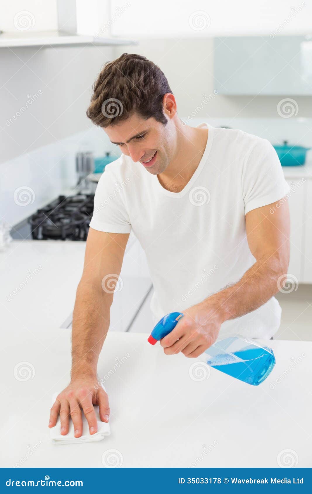 Smiling Young Man Cleaning Kitchen Counter Stock Photo - Image of ...