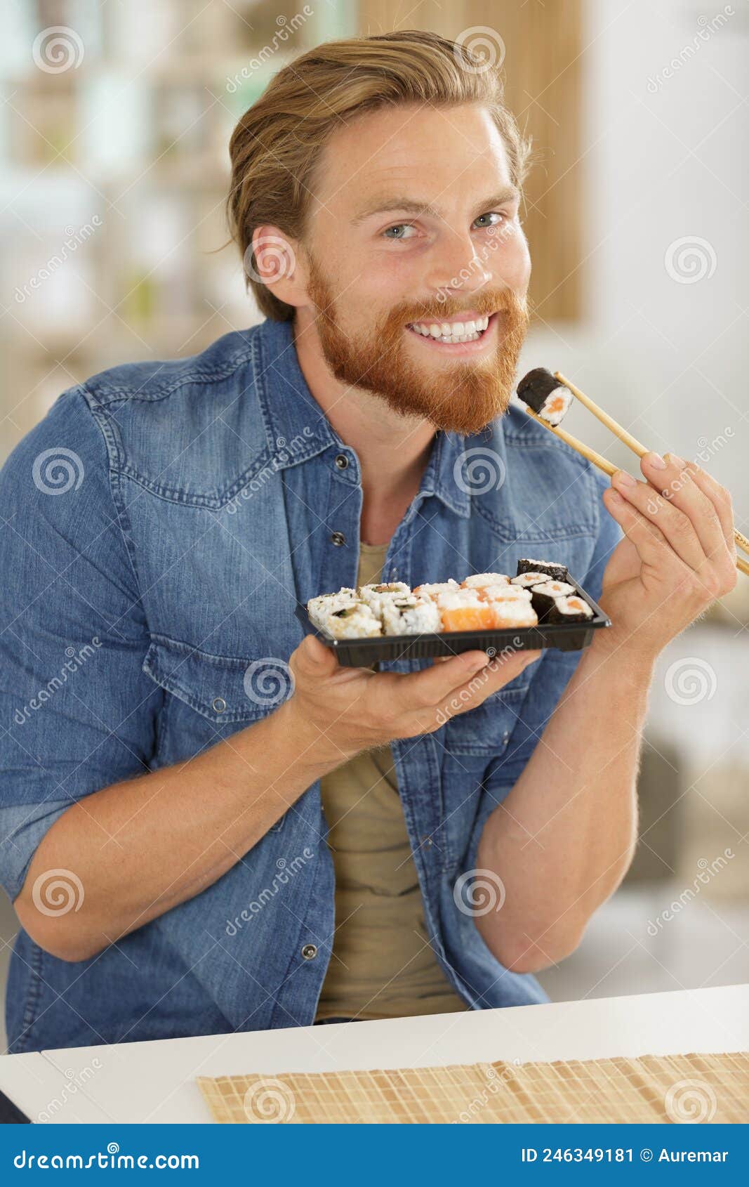 Smiling Young Man Eating Green Sushi Roll Stock Image - Image of male ...