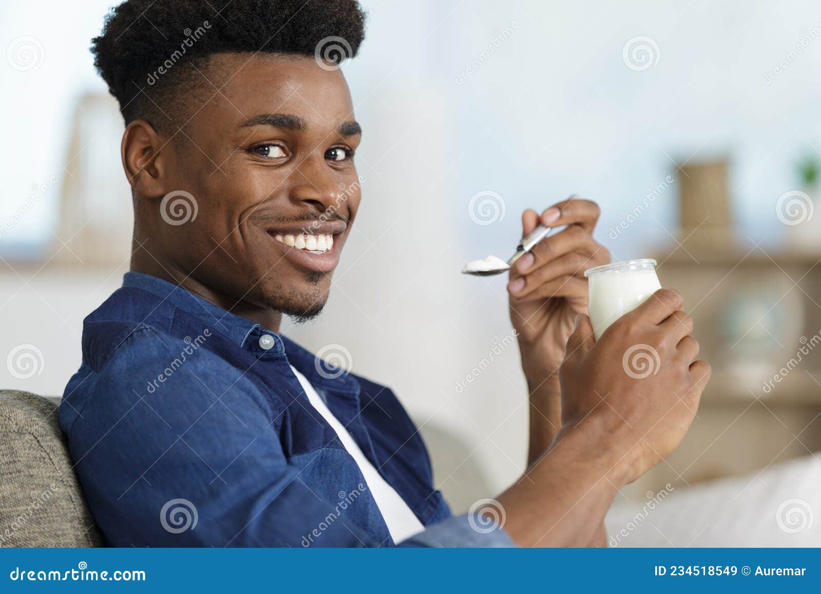 Smiling Young Man Eating Yogurt Stock Image - Image of spoon, healthy ...