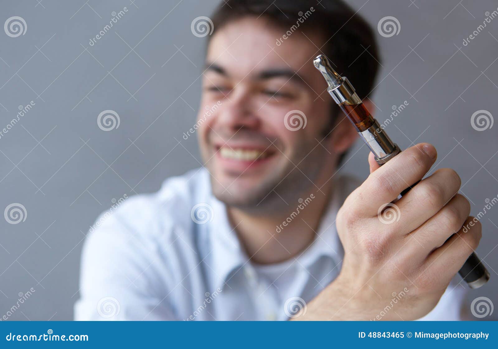 Smiling Young Man with Electric Cigarette Stock Image - Image of ...