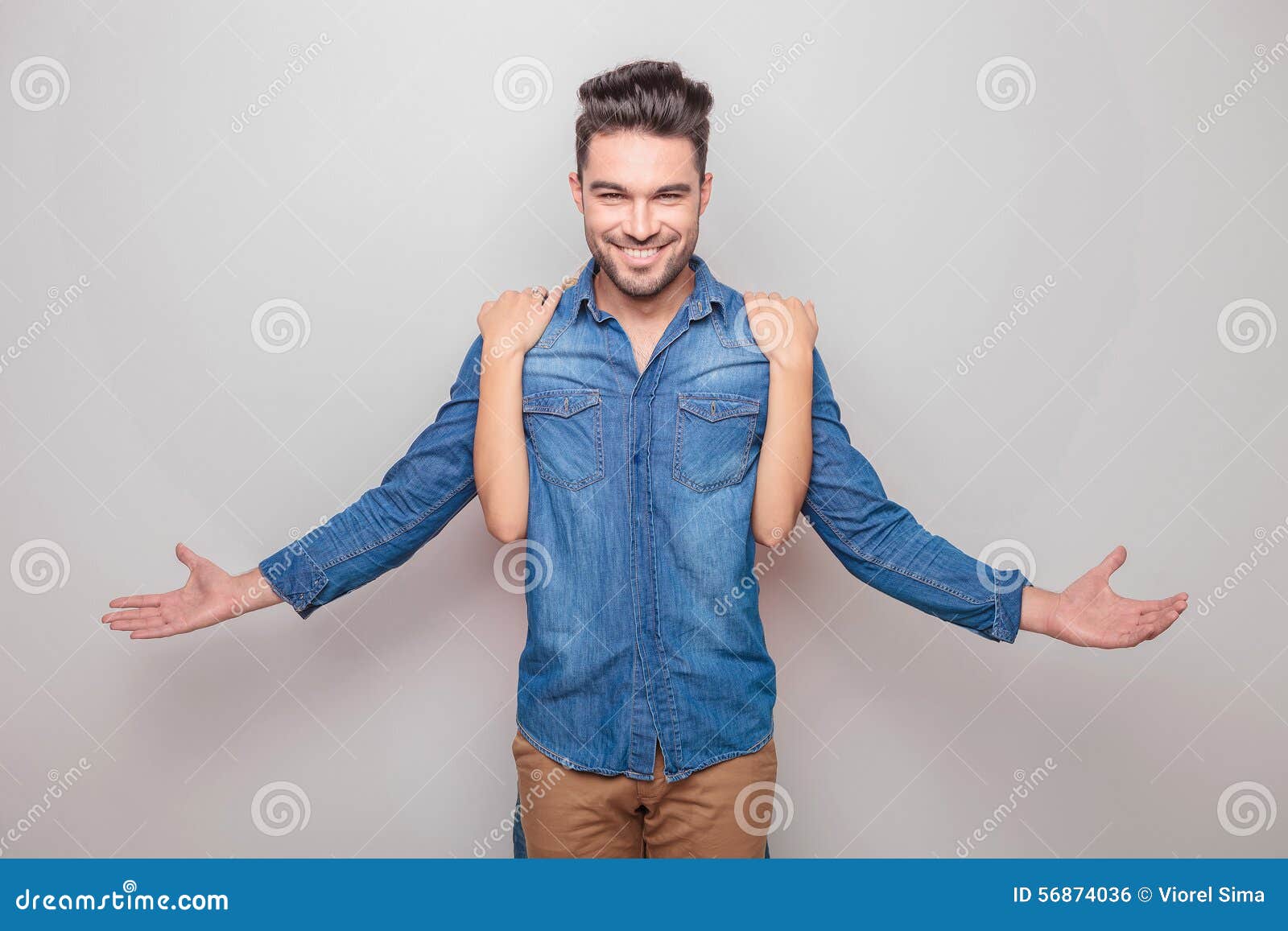 Smiling Young Man Holding His Hands Open Stock Photo - Image of jeans ...