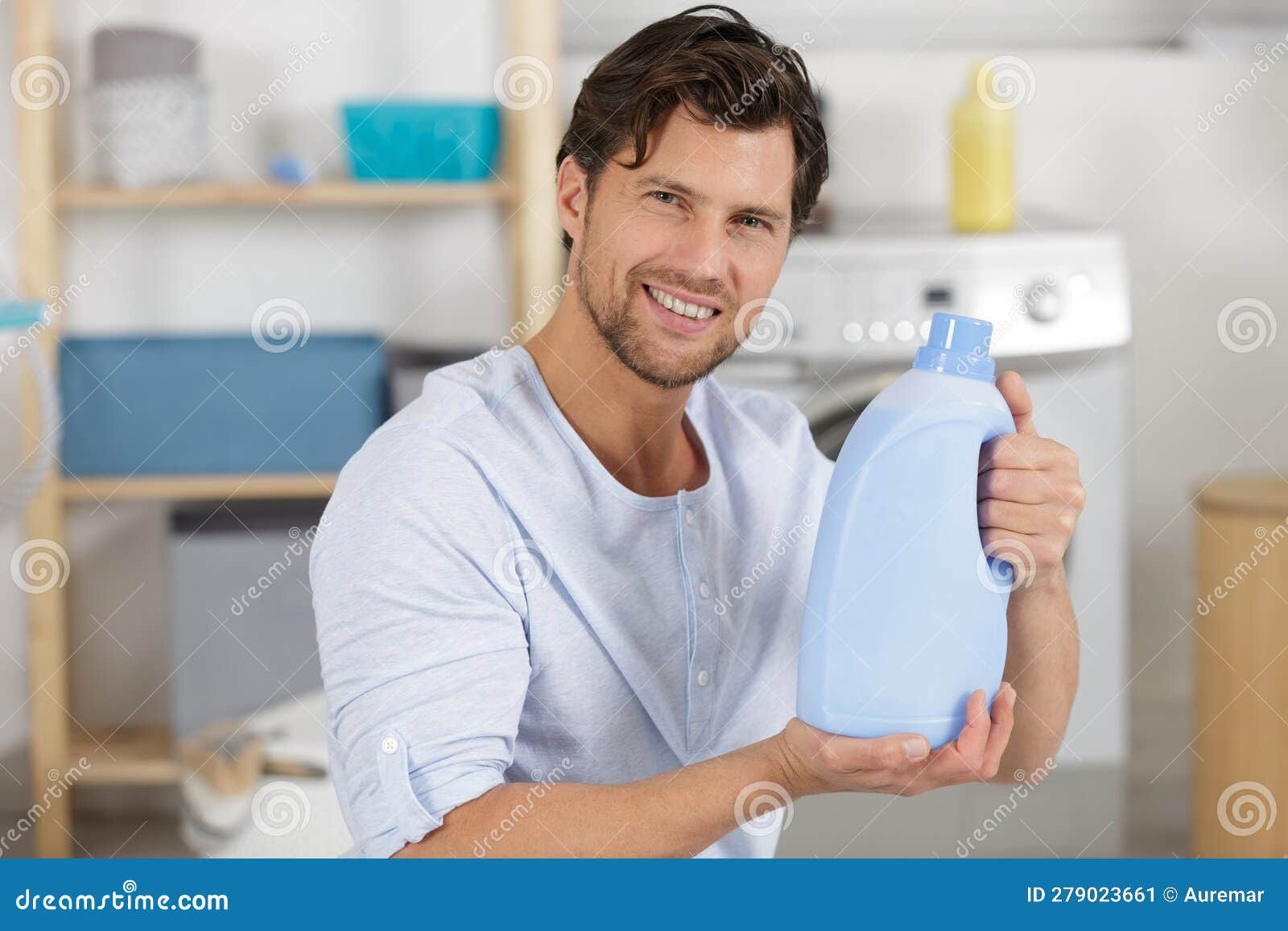 Smiling Young Man Holding Laundry Detergent Stock Image - Image of ...