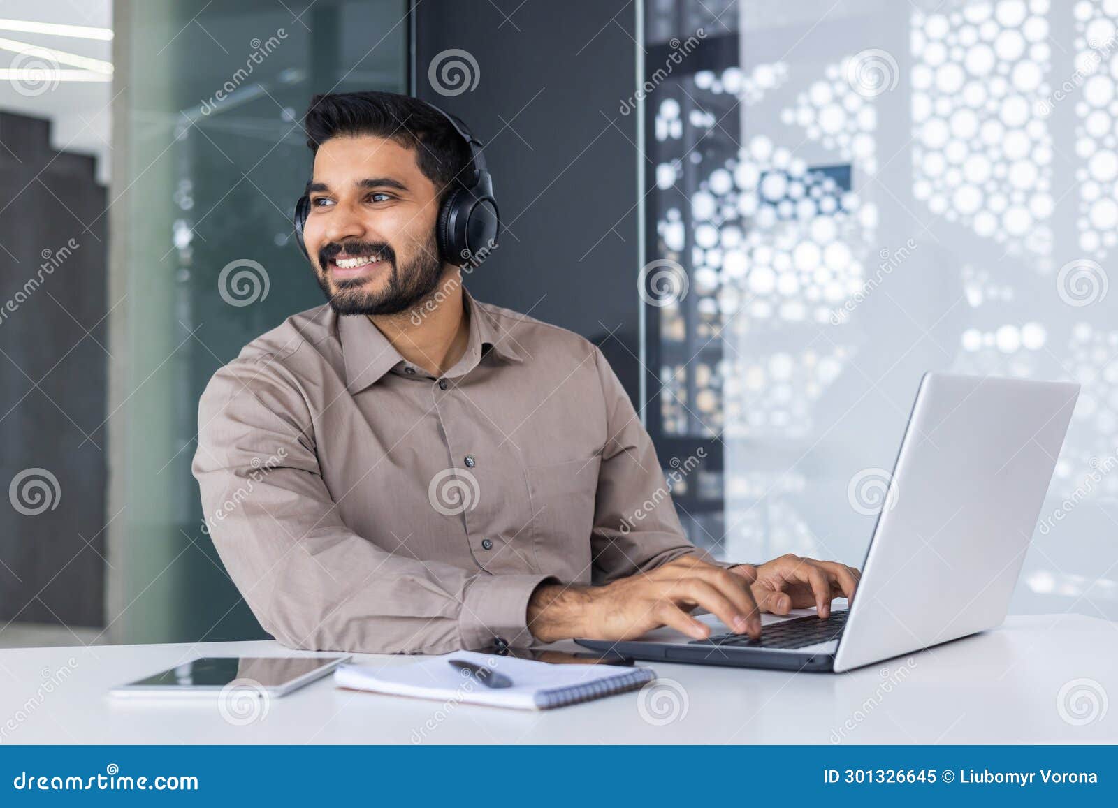 Smiling Young Man Indian Programmer and Developer Working in Headphones ...