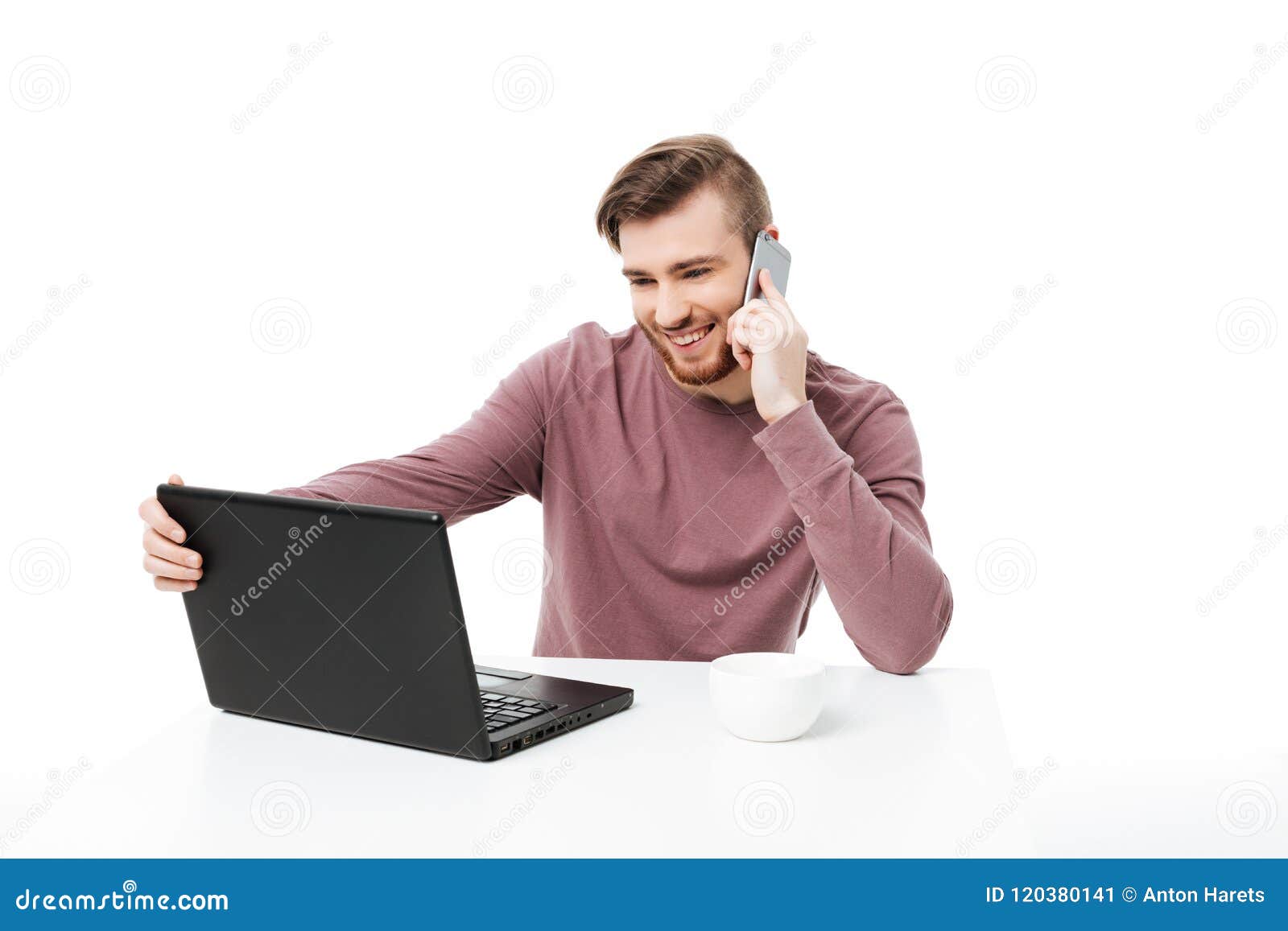 Smiling Young Man Looking at the Display of Computer Talking on the ...