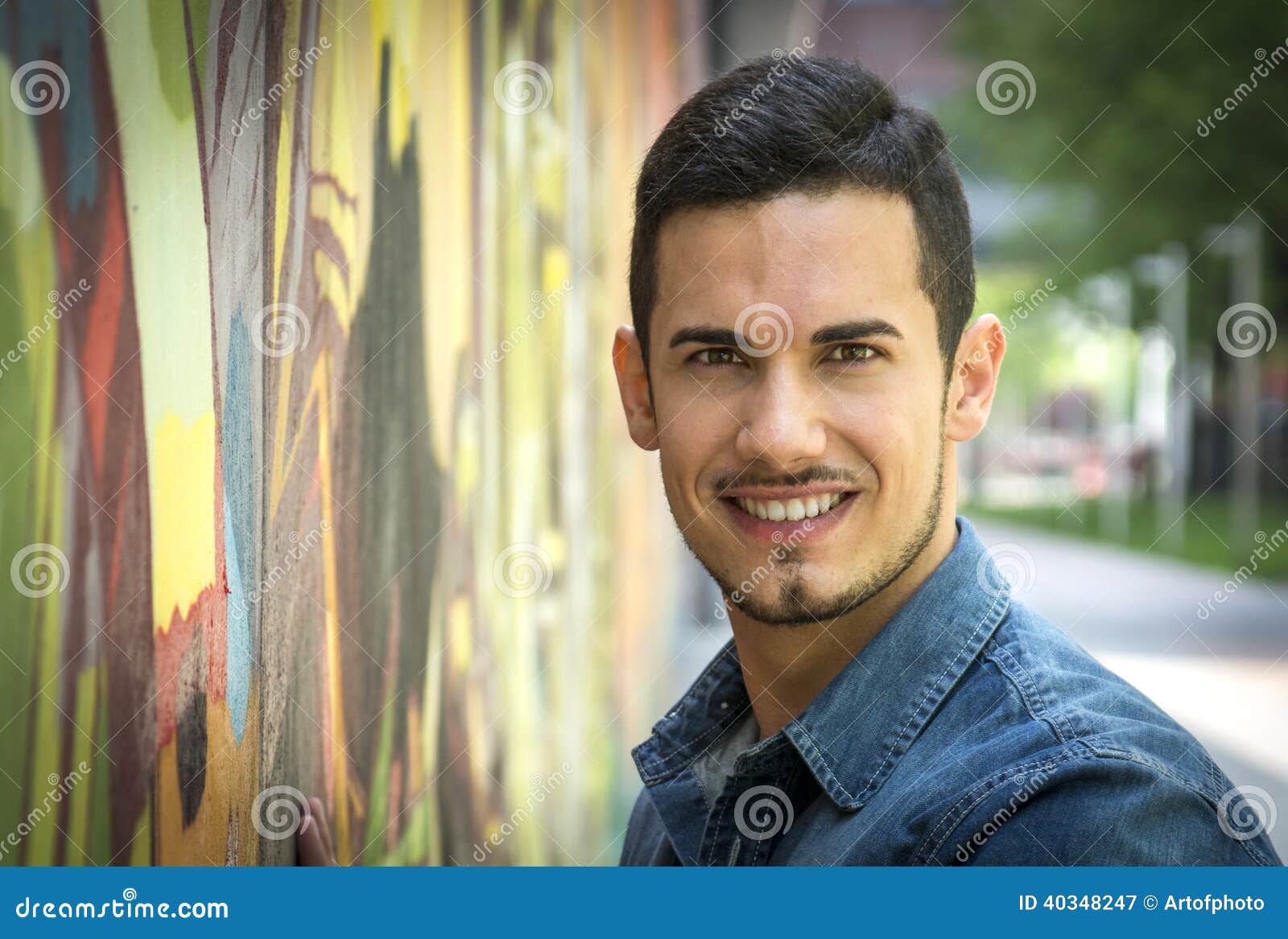 Smiling Young Man Next To Colorful Graffiti Wall Stock Image - Image of ...