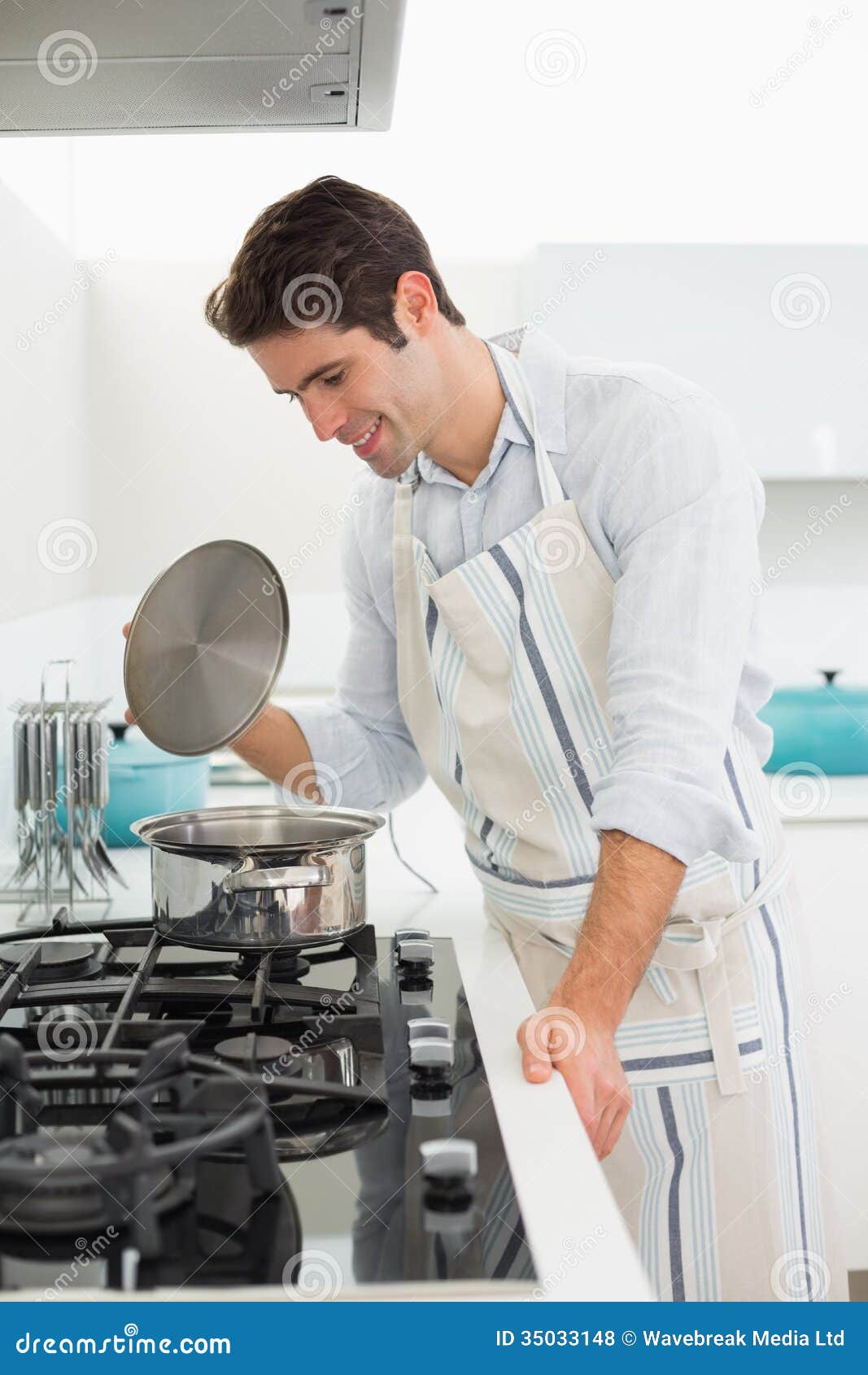 Smiling Young Man Preparing Food in Kitchen Stock Photo - Image of view ...