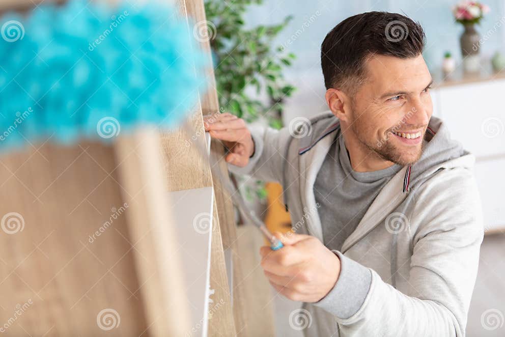 Smiling Young Man Reaching Something in Shelf Stock Image - Image of ...