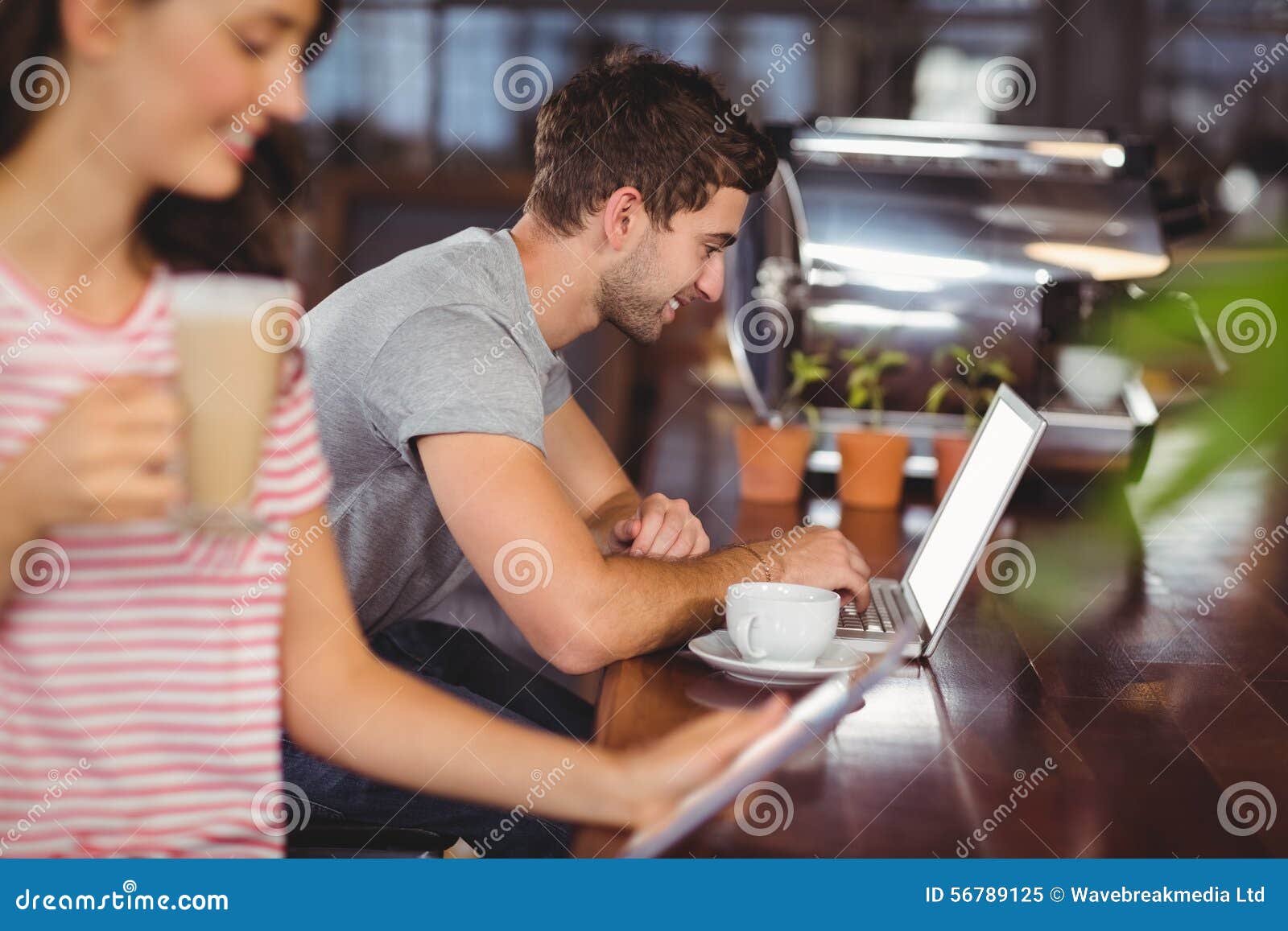 Smiling Young Man Sitting at Bar and Using Laptop Stock Image - Image ...