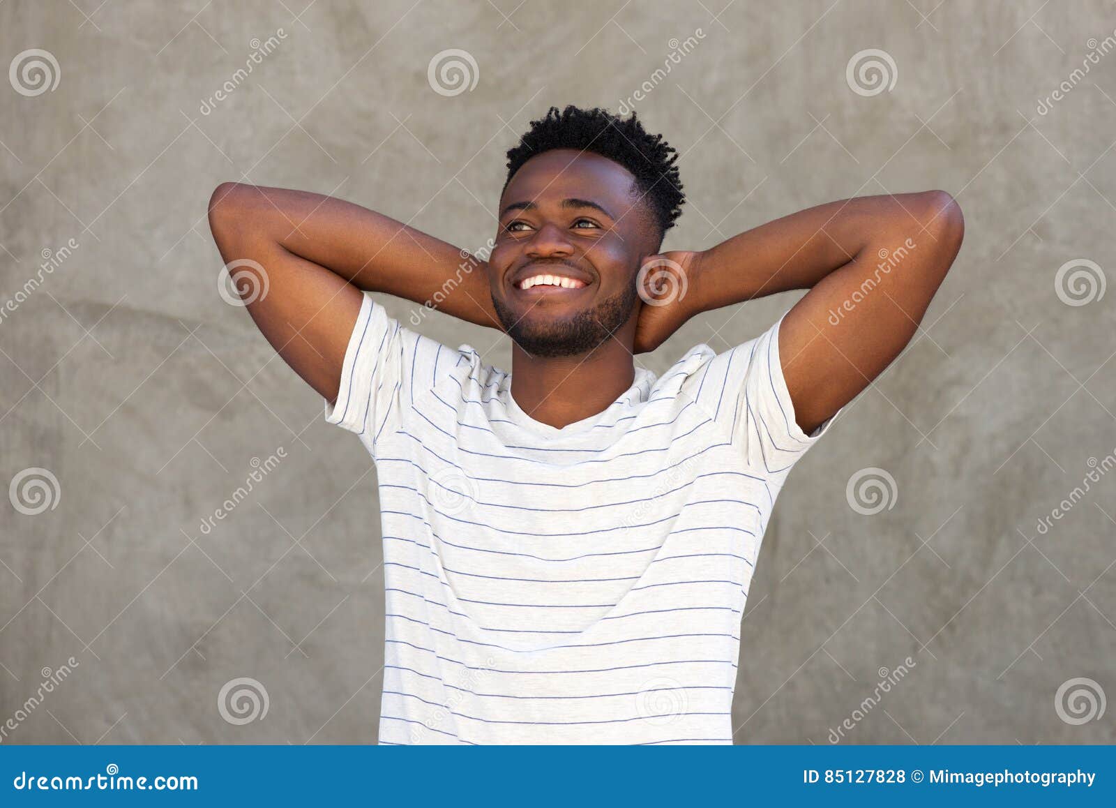 Smiling Young Man Standing with Hands Behind Head Stock Photo - Image ...