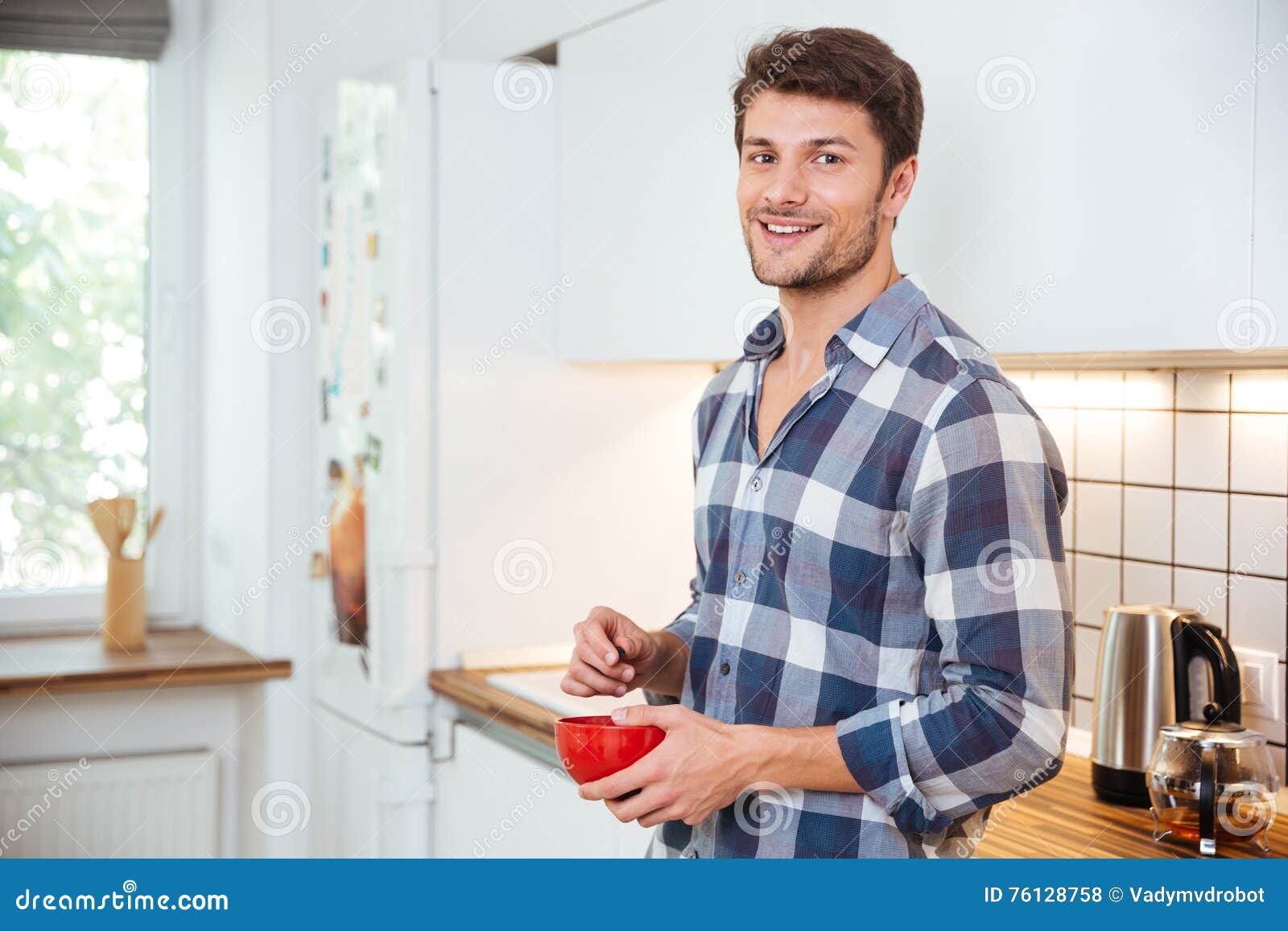 Smiling Young Man Standing on the Kitchen Stock Photo - Image of hold ...