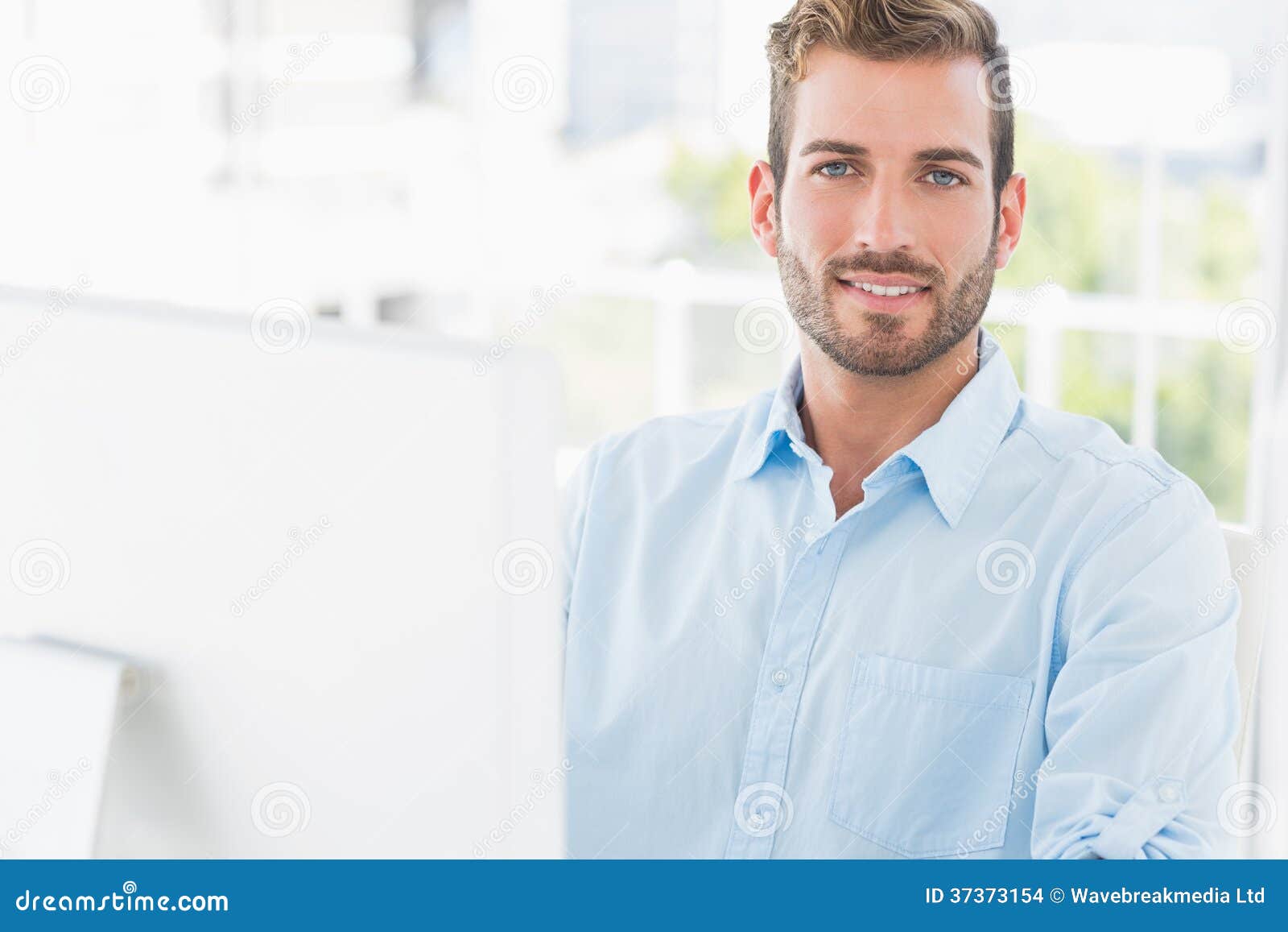Smiling Young Man Using Computer in Office Stock Photo - Image of ...