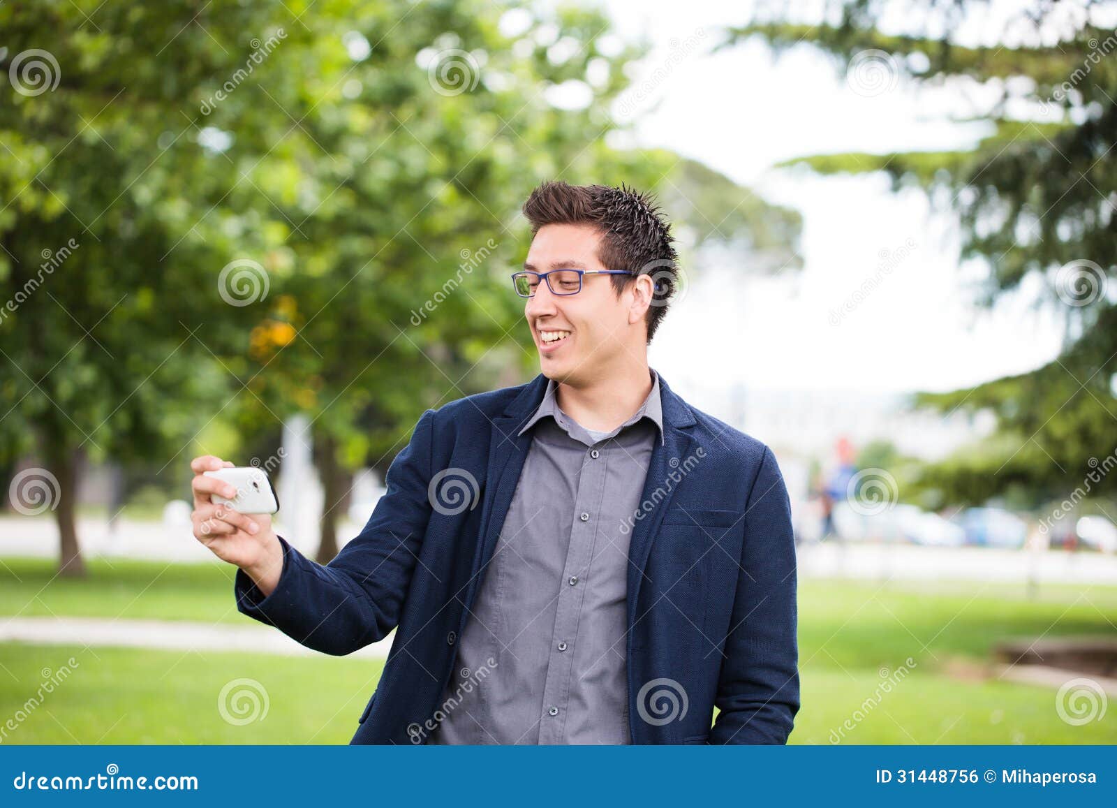 Smiling Young Man Using His Smart Phone Stock Photo - Image of call ...