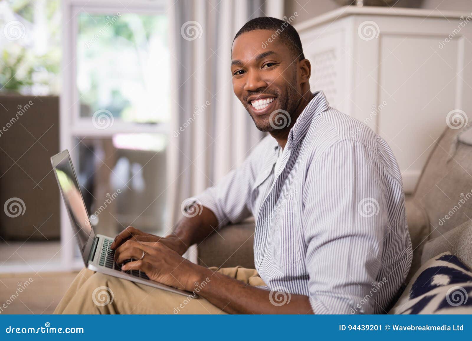 Smiling Young Man Using Laptop at Home Stock Image - Image of home ...