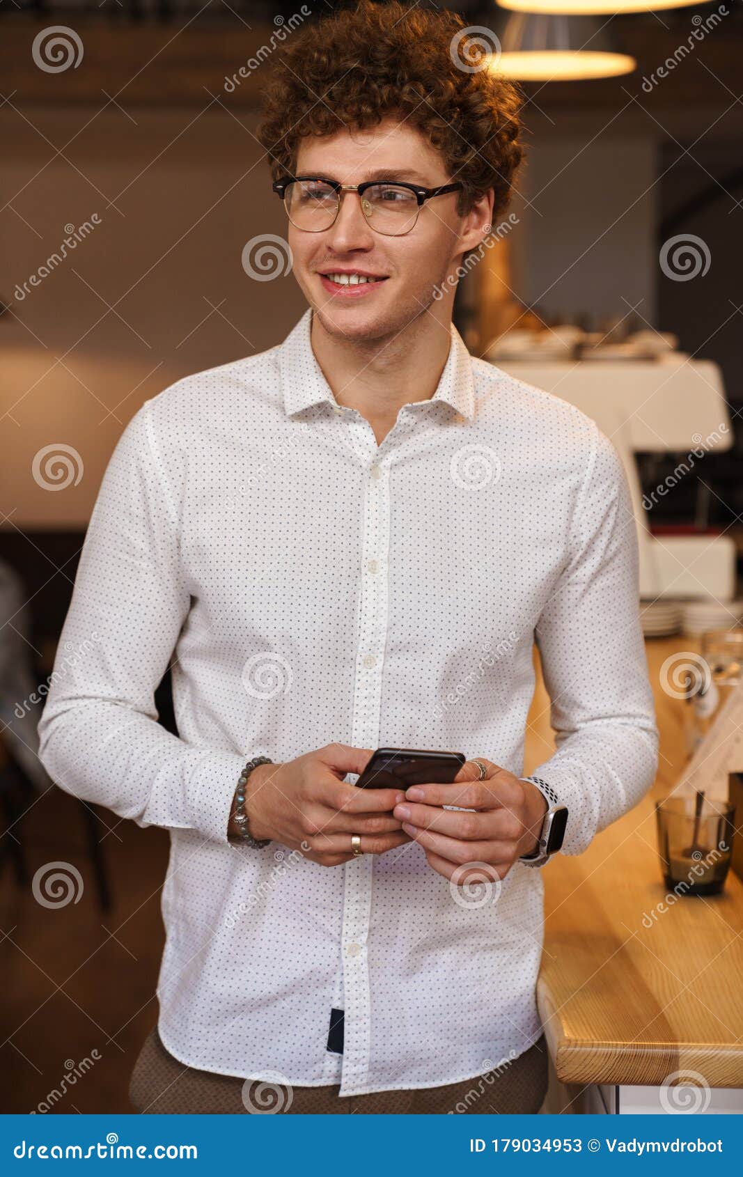 Smiling Young Man Using Mobile Phone while Standing Stock Image - Image ...