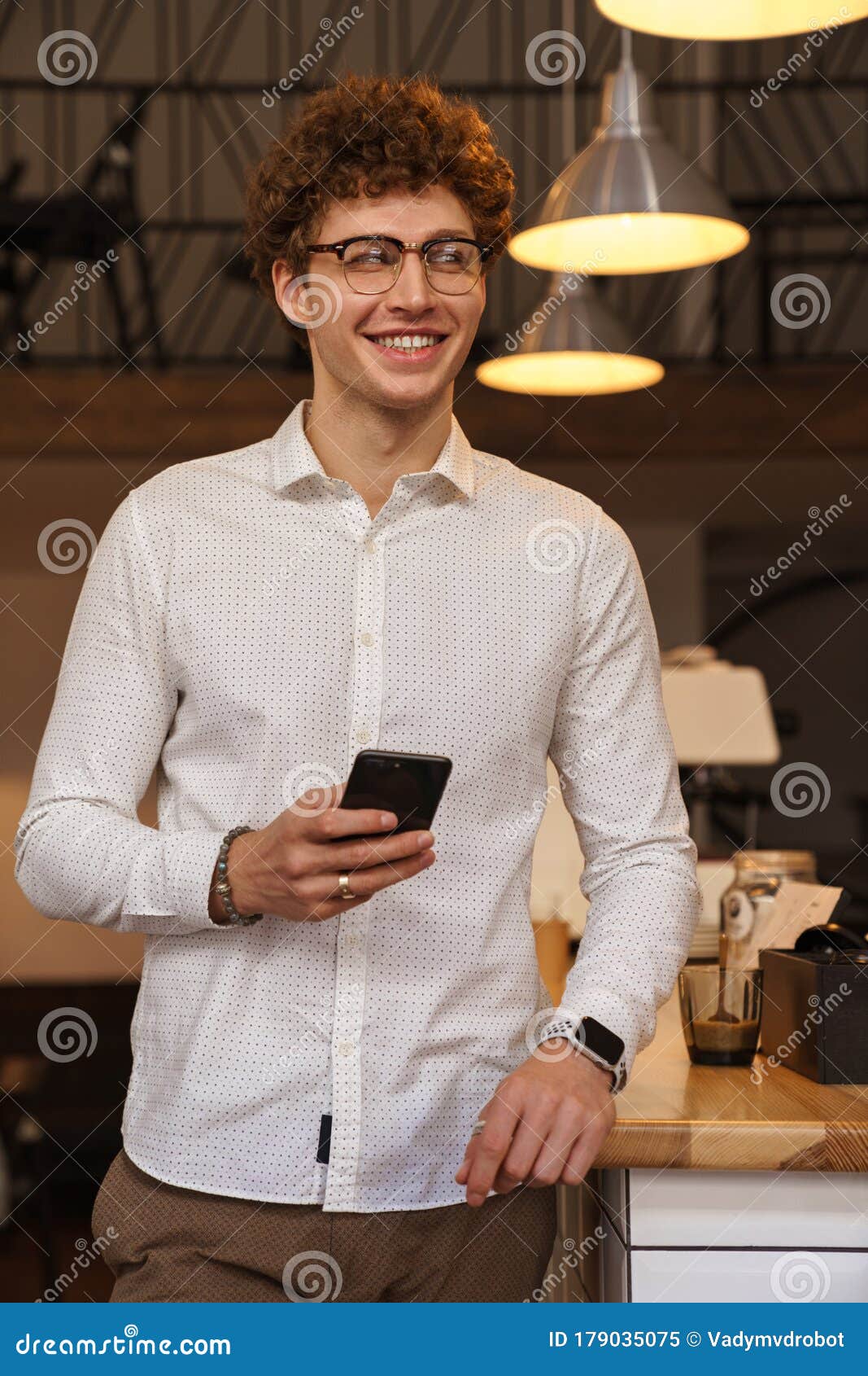 Smiling Young Man Using Mobile Phone while Standing Stock Image - Image ...