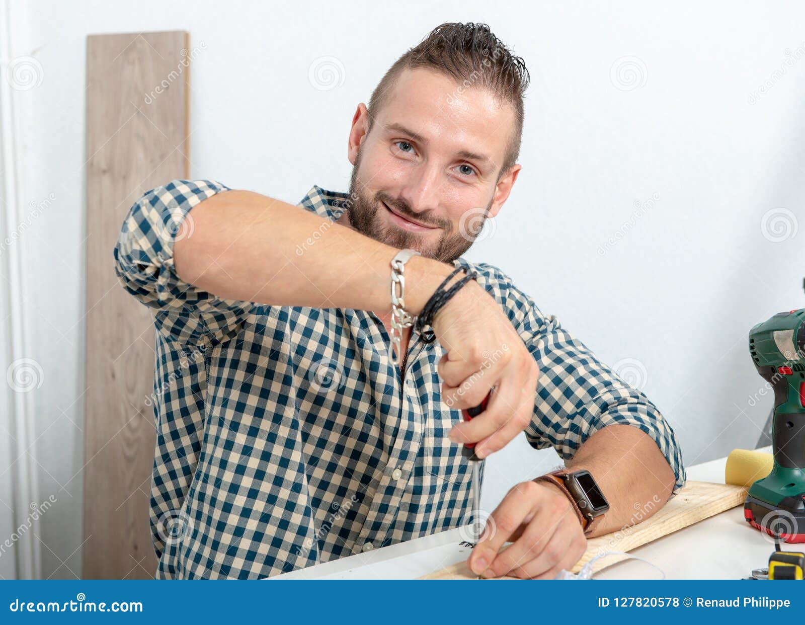 Smiling Young Man Using Screwdriver at Home Stock Photo - Image of ...