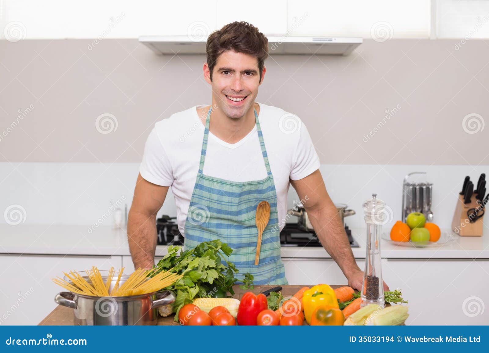 Smiling Young Man with Vegetables Standing in Kitchen Stock Photo ...
