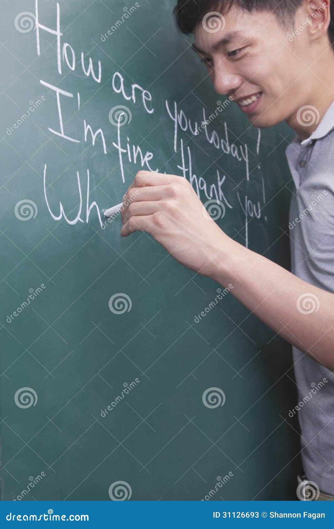 Smiling Young Man Writing English Sentences on the Blackboard Stock ...