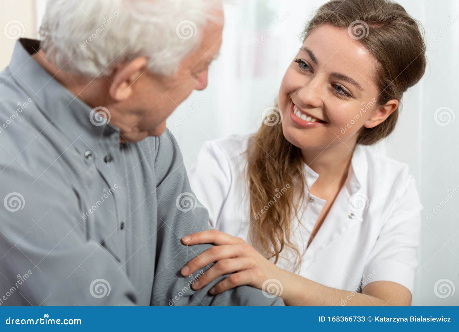 Smiling Nurse Sitting at Table with Senior Patient Stock Image - Image ...