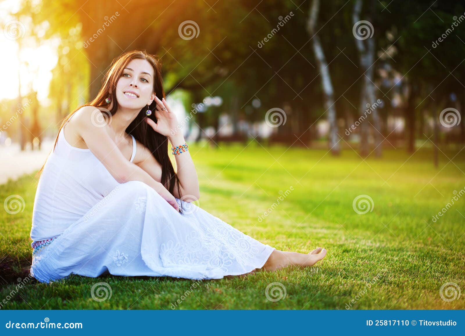 Smiling Young Pretty Girl is Sitting on the Grass Stock Photo - Image ...