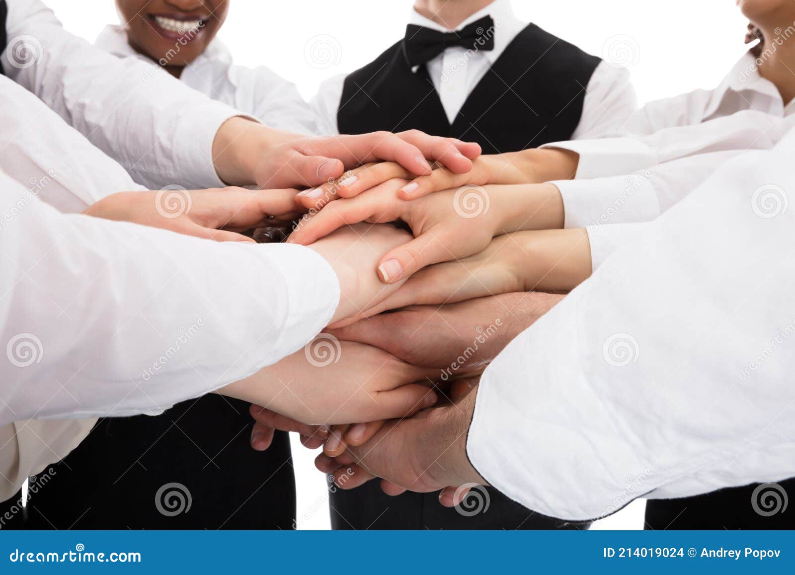 Smiling Young Restaurant Staff Stacking Hands Stock Photo - Image of ...