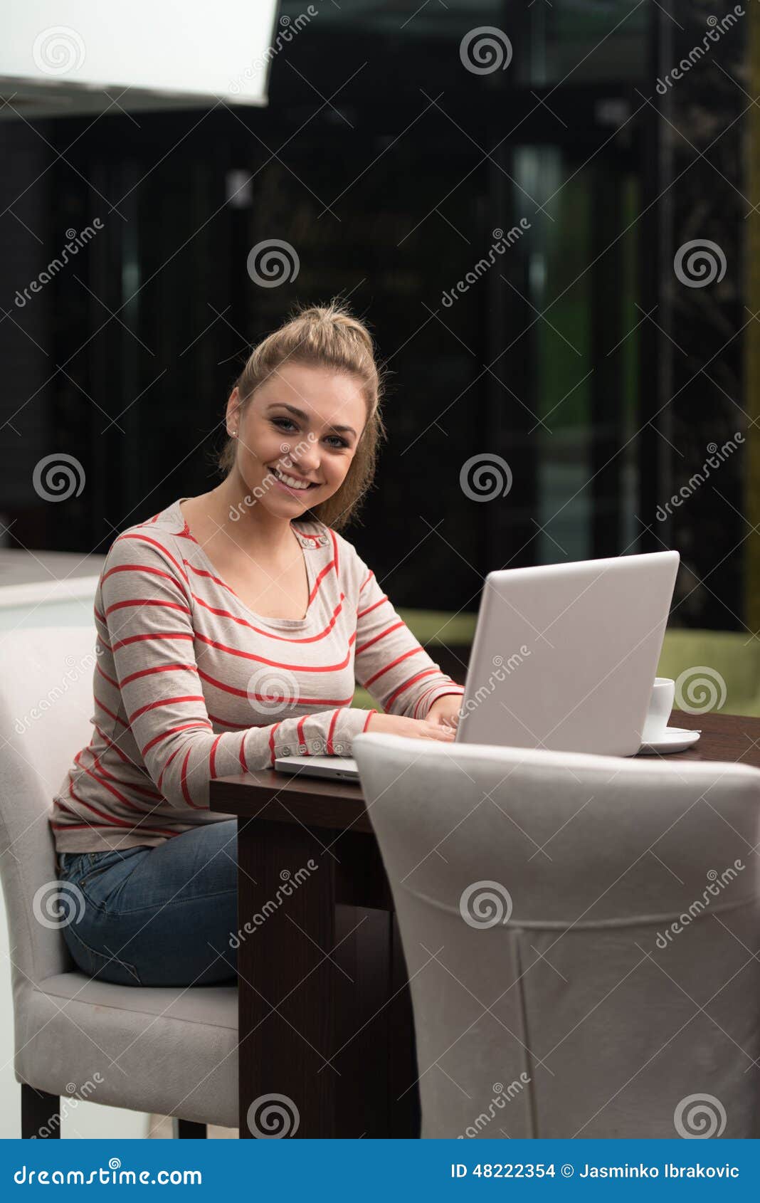 Smiling Young Student in Cafe Using Laptop Stock Photo - Image of ...
