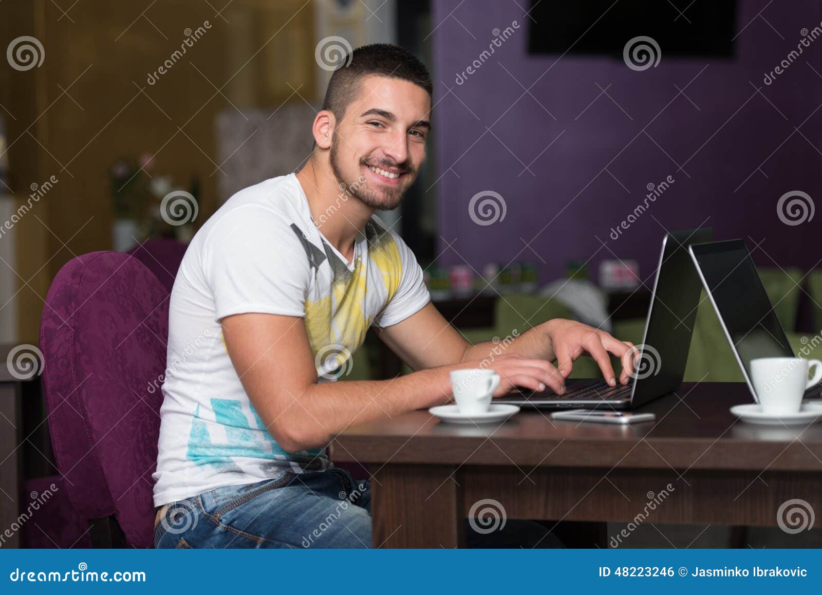 Smiling Young Student in Cafe Using Laptop Stock Photo - Image of ...