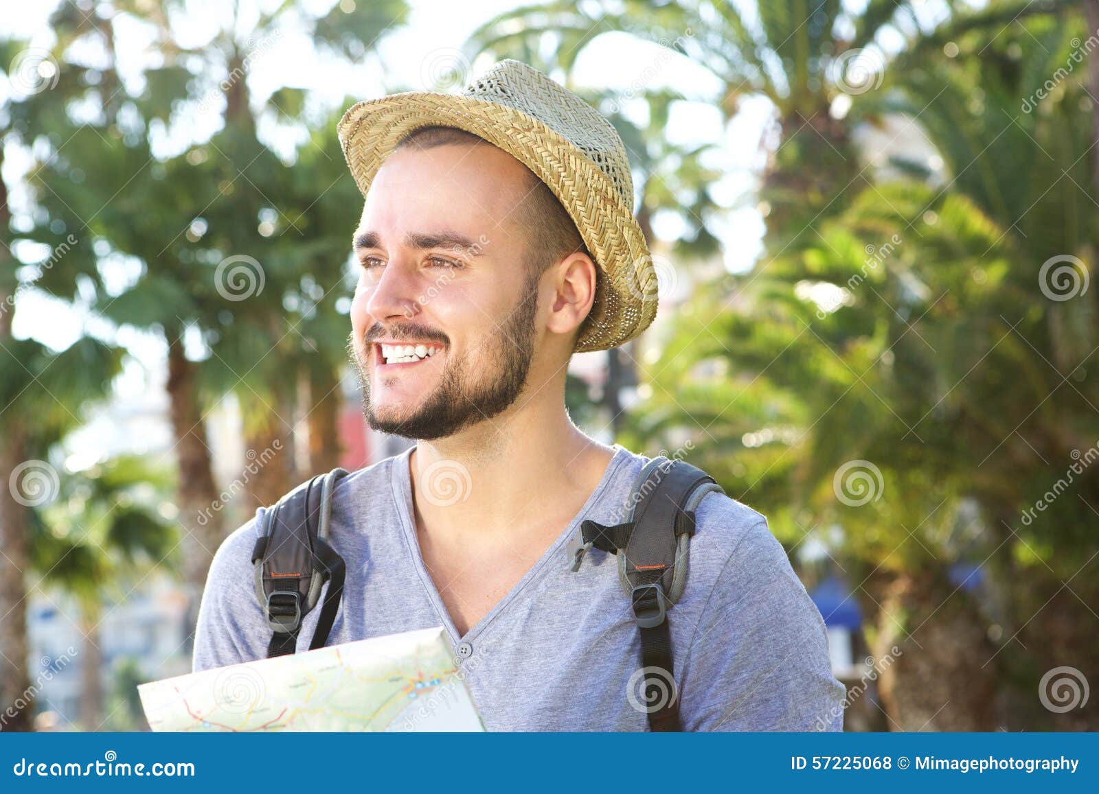 Smiling Young Traveling Guy Holding Map Outside Stock Photo - Image of ...