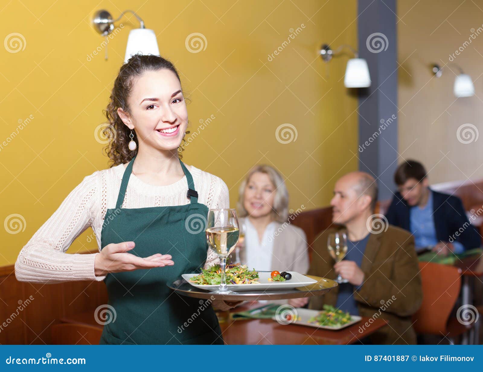 Smiling Young Waitress Greeting Customers Stock Image - Image of ...