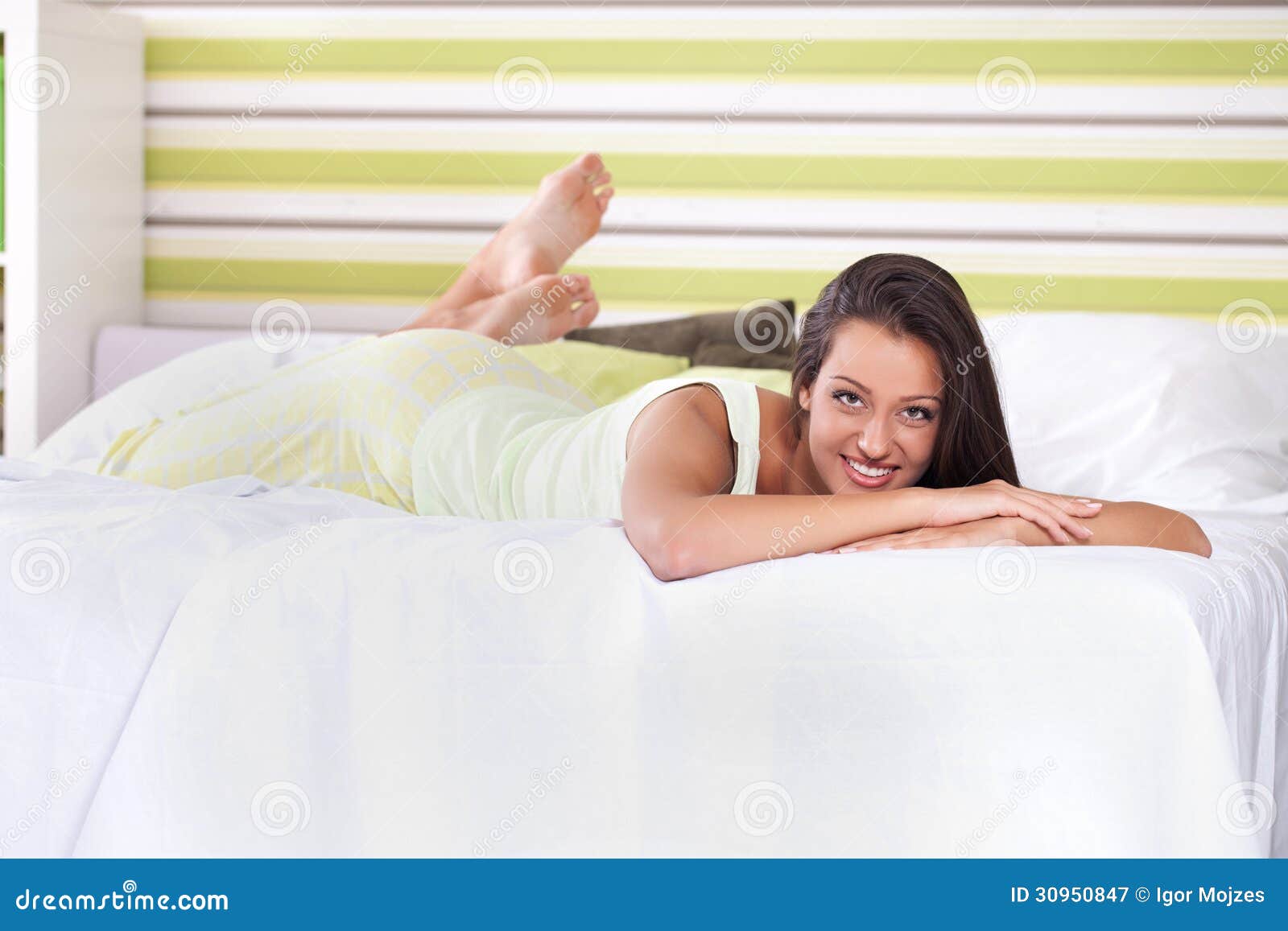Smiling young woman in bed stock image. Image of girl - 30950847