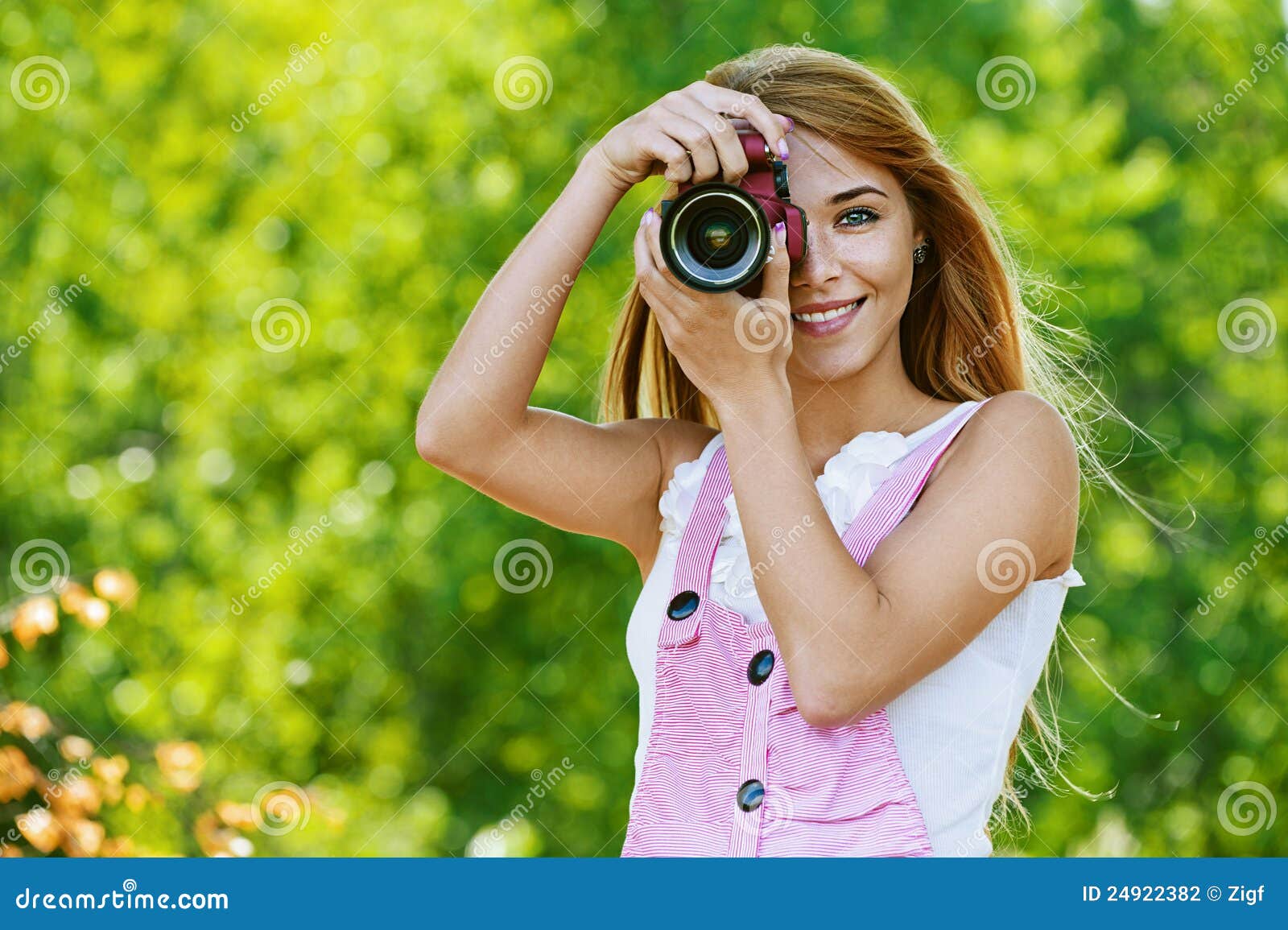 Smiling Young Woman with Camera Stock Photo - Image of photographer ...