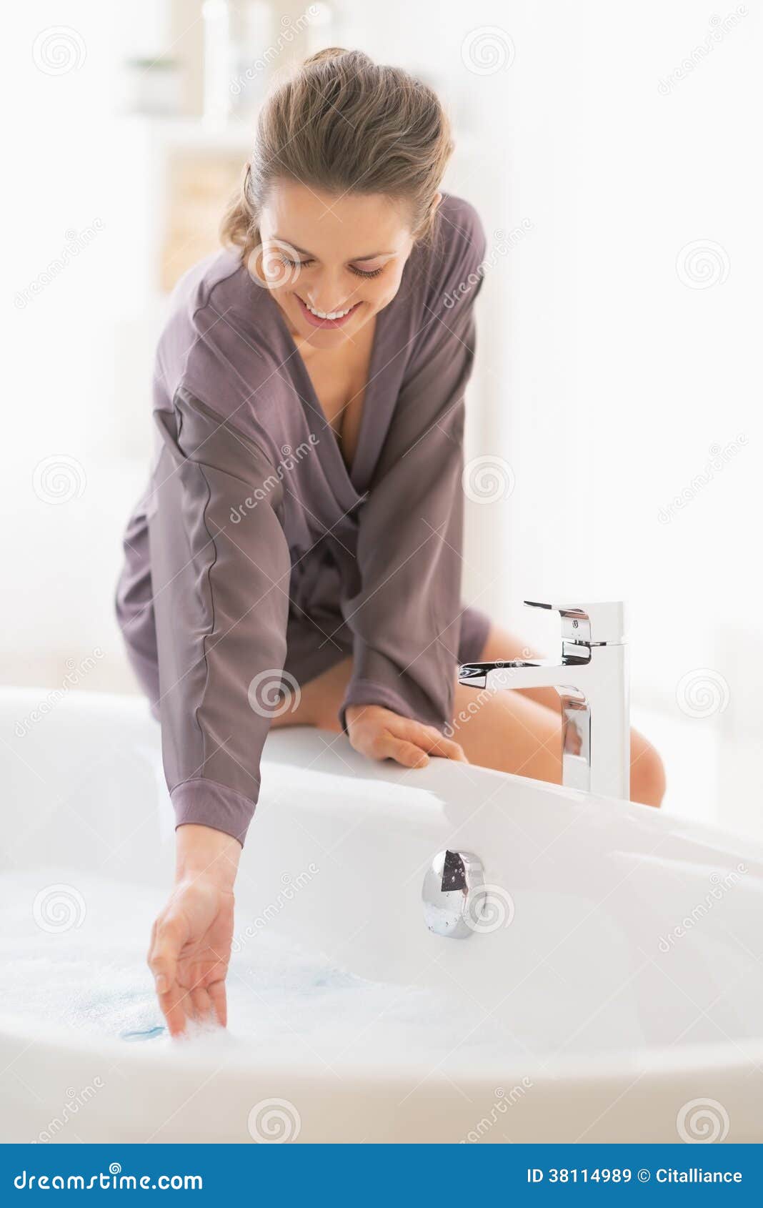 Smiling Young Woman Checking Water Temperature in Bathtub Stock Image ...
