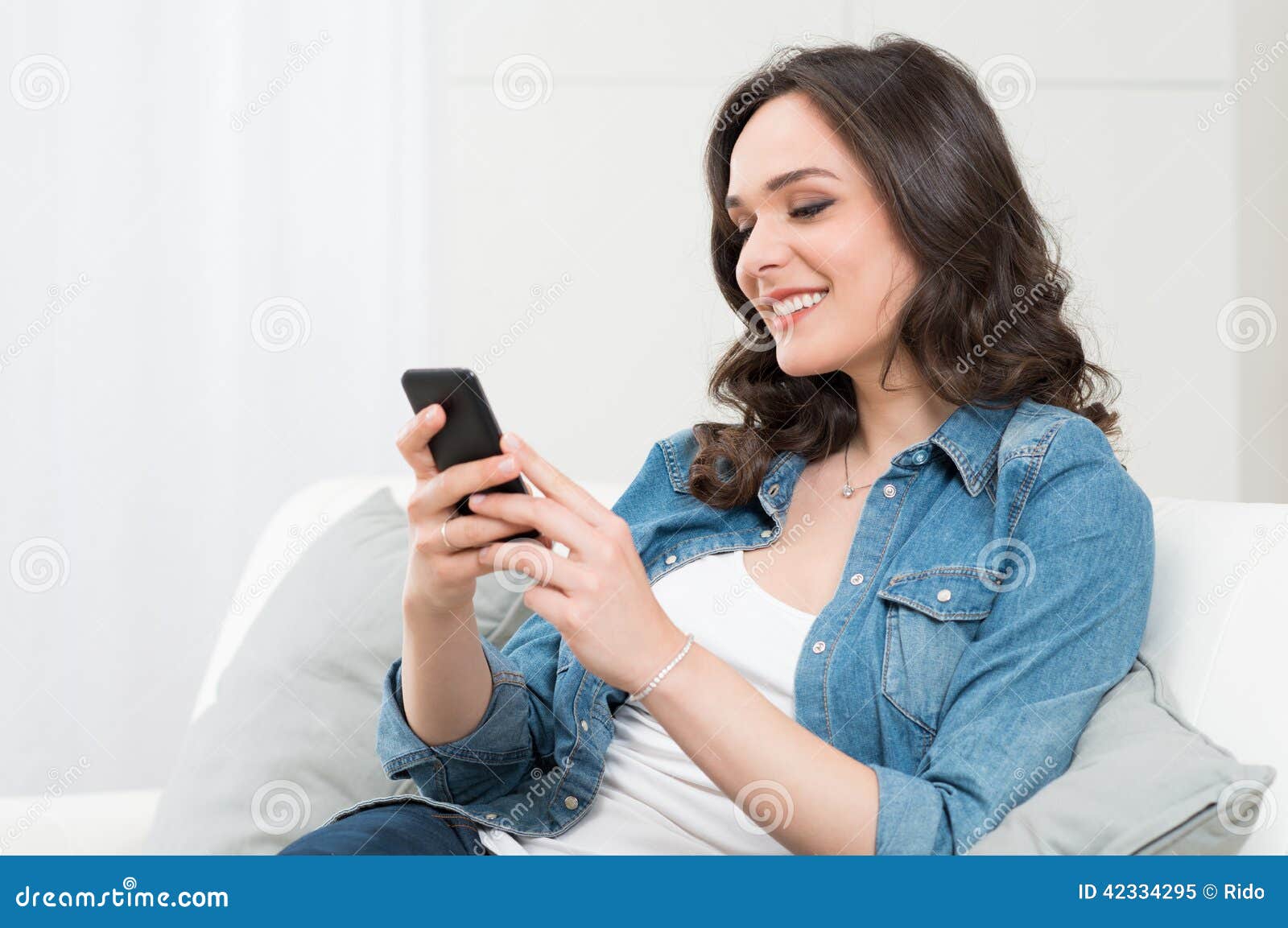 Smiling Young Woman Holding Cellphone Stock Image - Image of lady ... Smiling Young Woman Holding Cellphone Stock Image - Image of lady ...