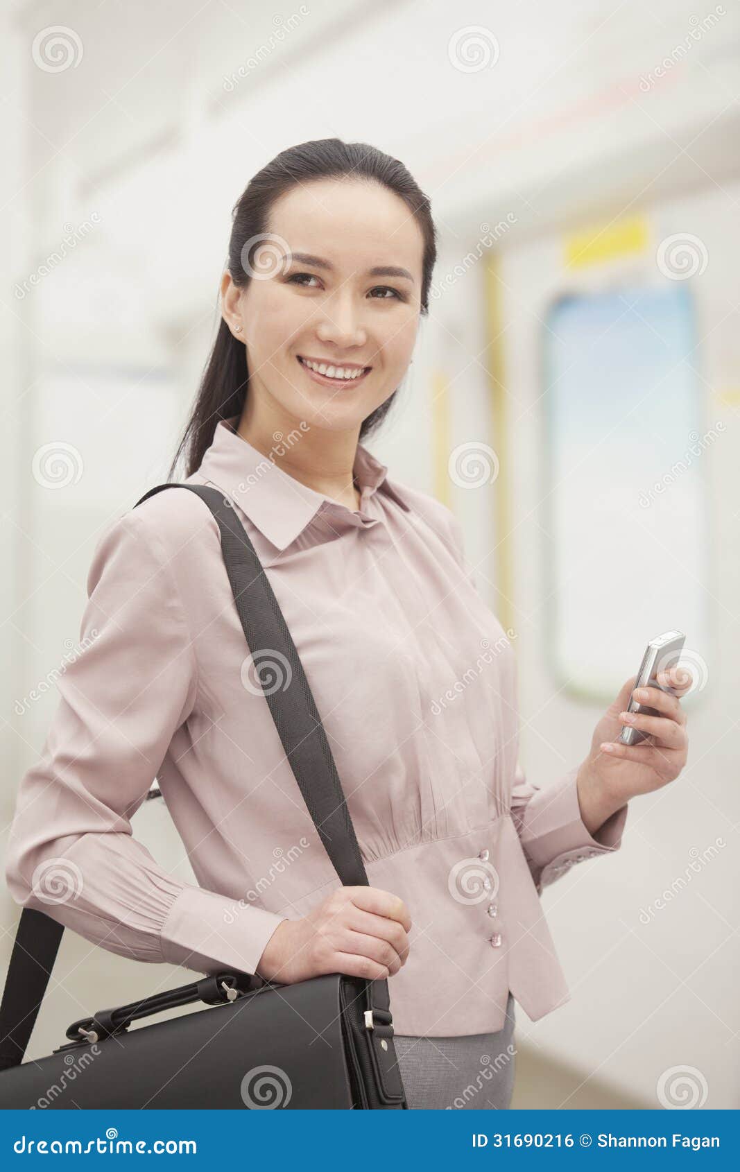 Smiling Young Woman Holding Mobile Phone Stock Photo - Image of away ...